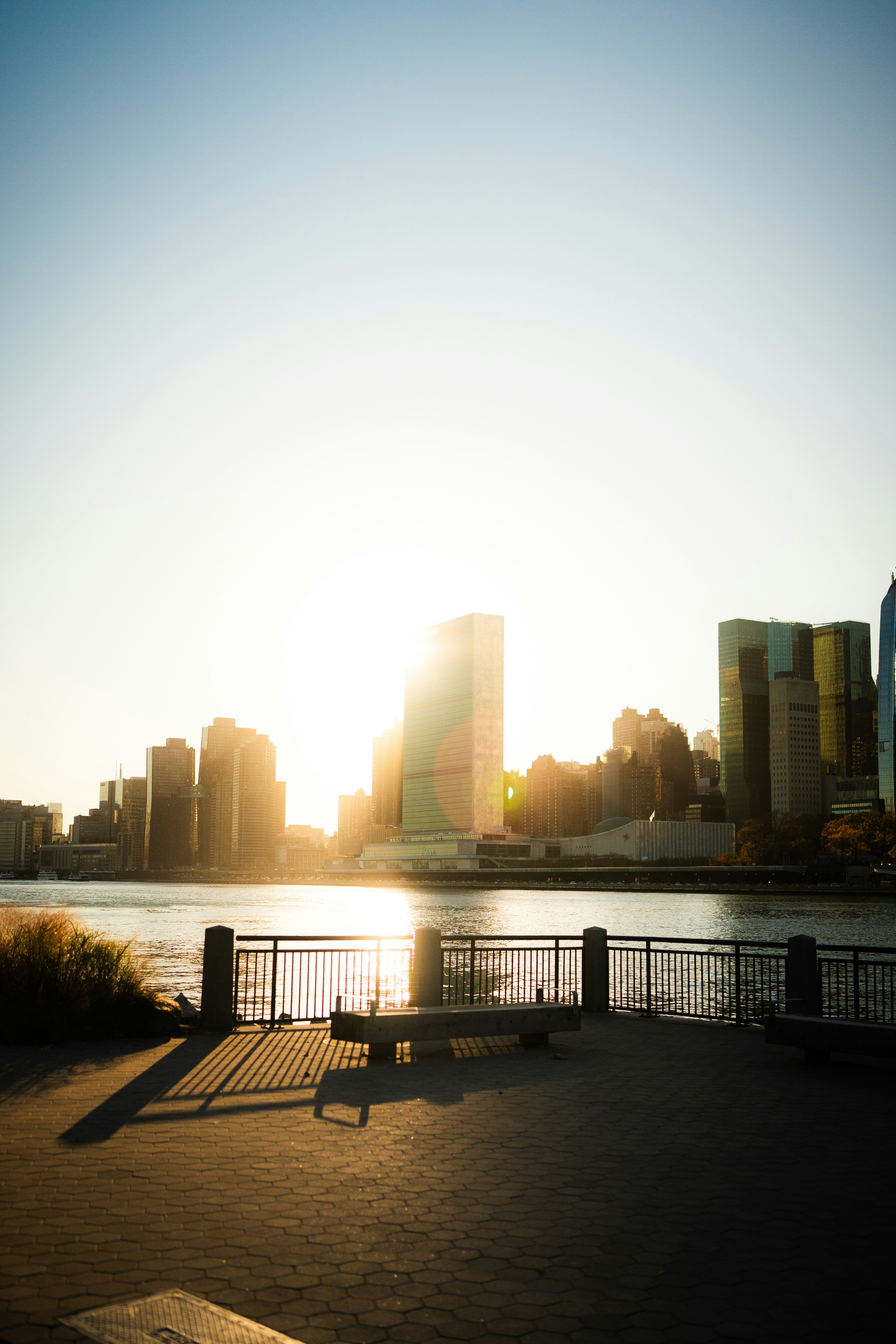 The sun is setting over the city skyline photo – Free New york Image on ...