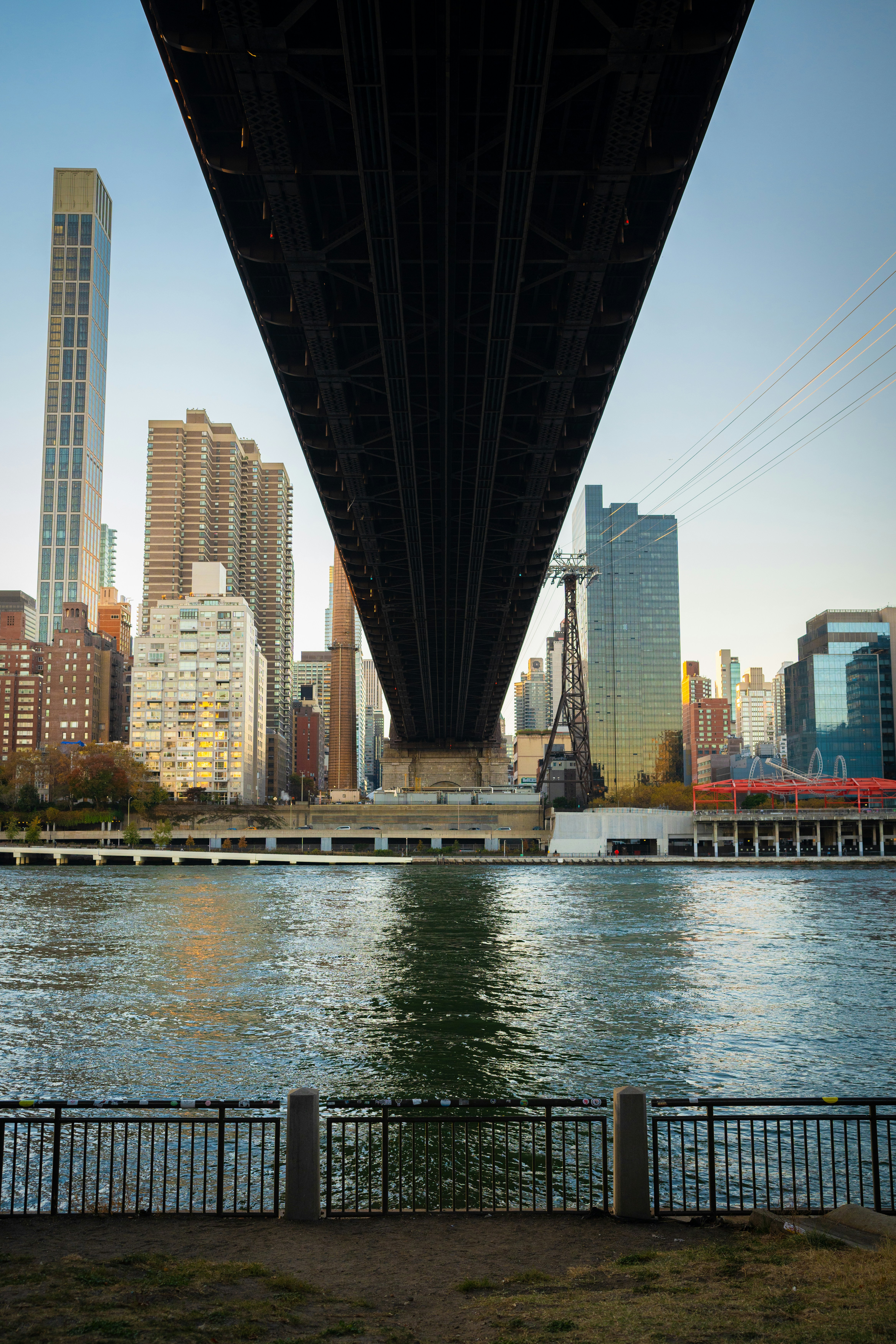 Under the Iron Span: Riverfront Skyline Framed by a Monolithic Bridge