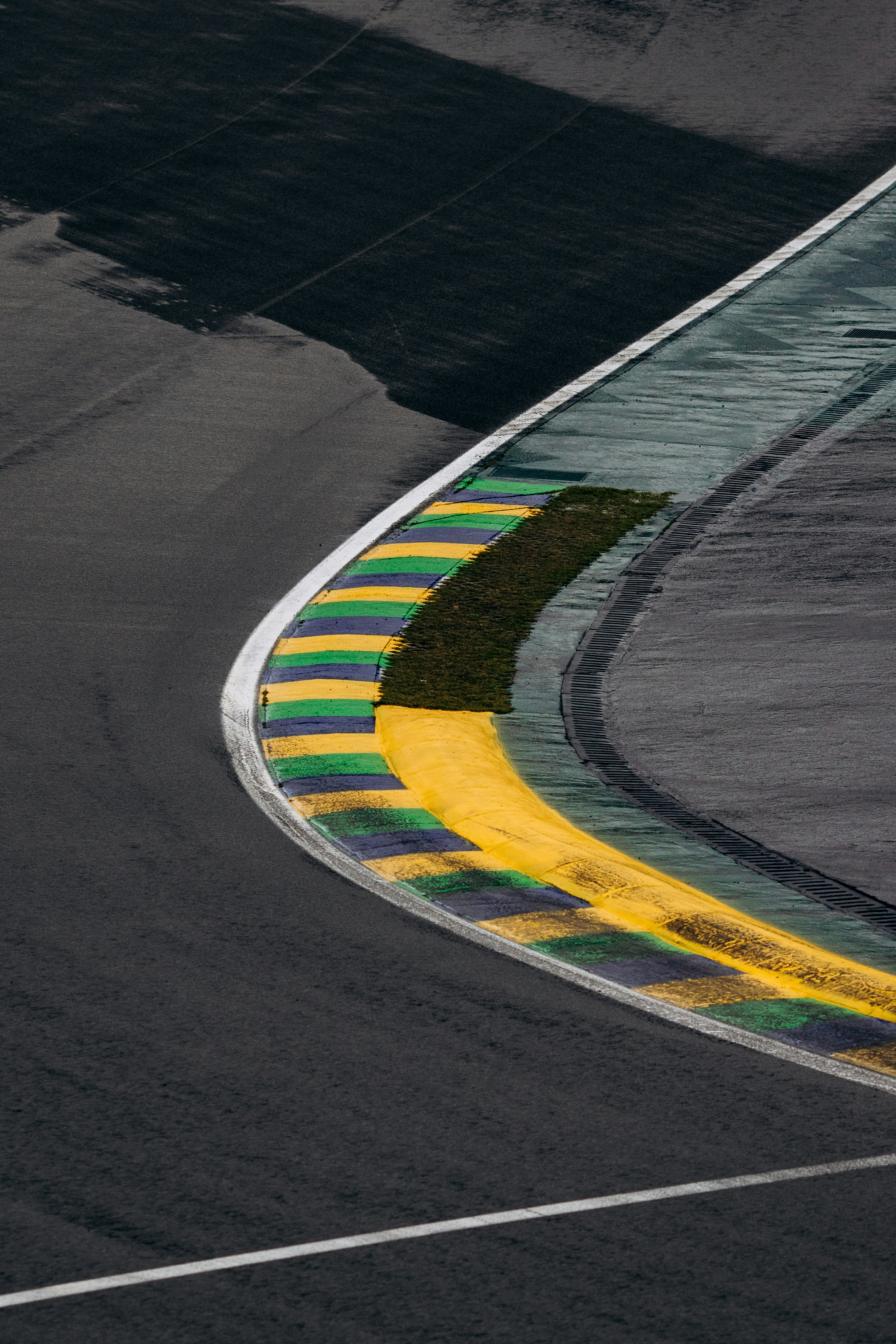 Curved Asphalt Symphony: Neon Curbs and Painted Turn Markings
