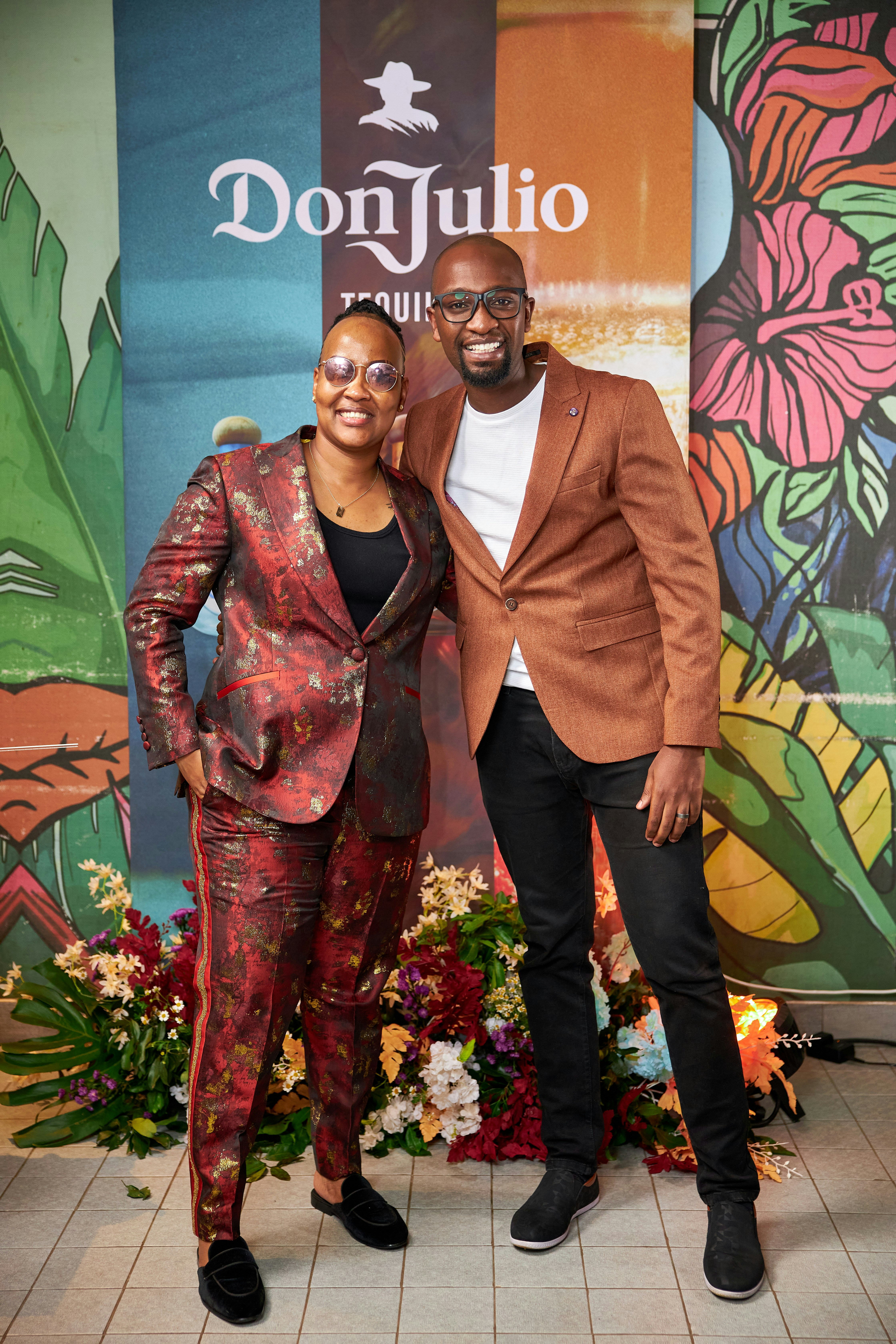 Chromatic Celebration: Duo in Patterned Suits Before a Don Julio Backdrop