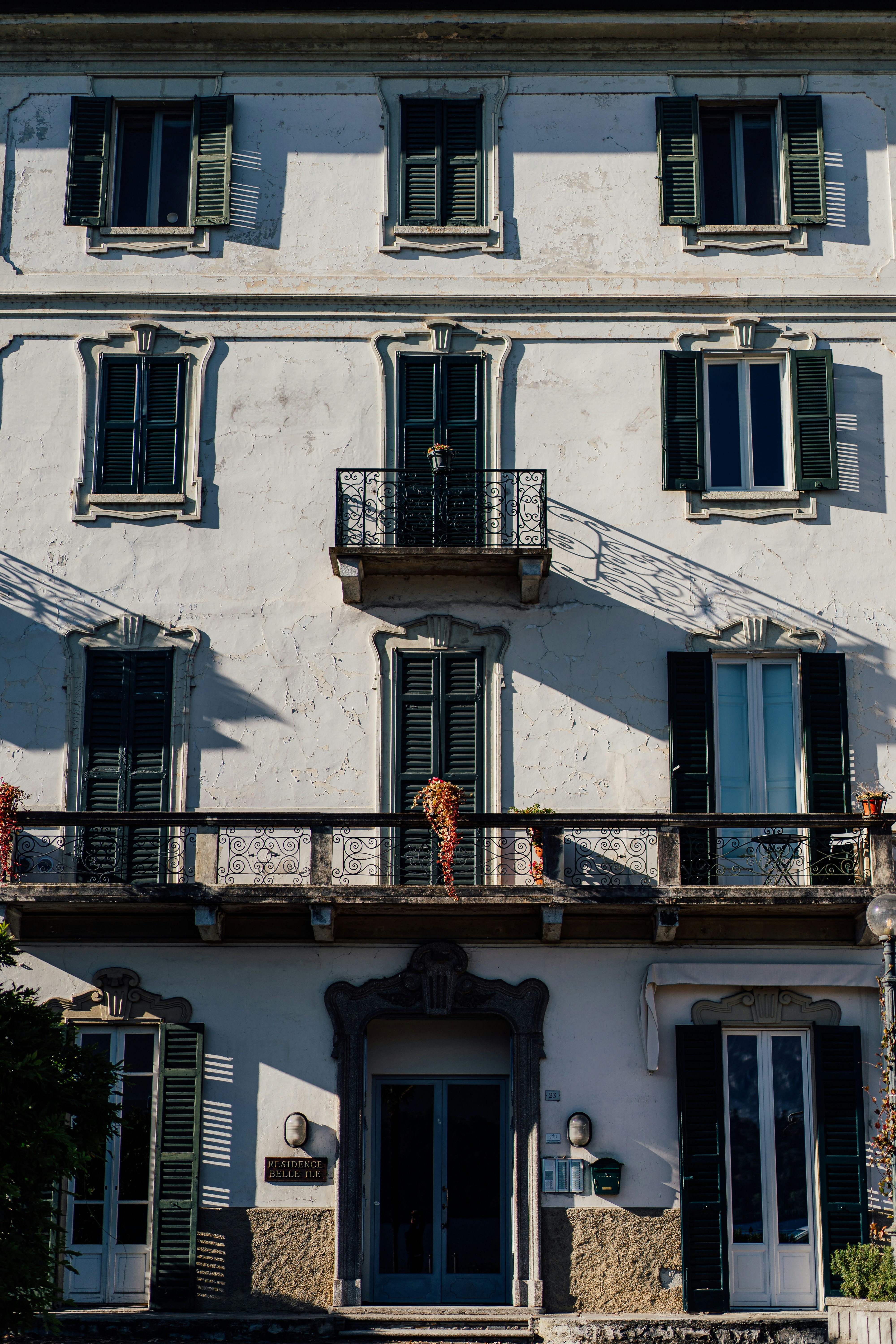 The Silent Figure on a Sunlit European Facade
