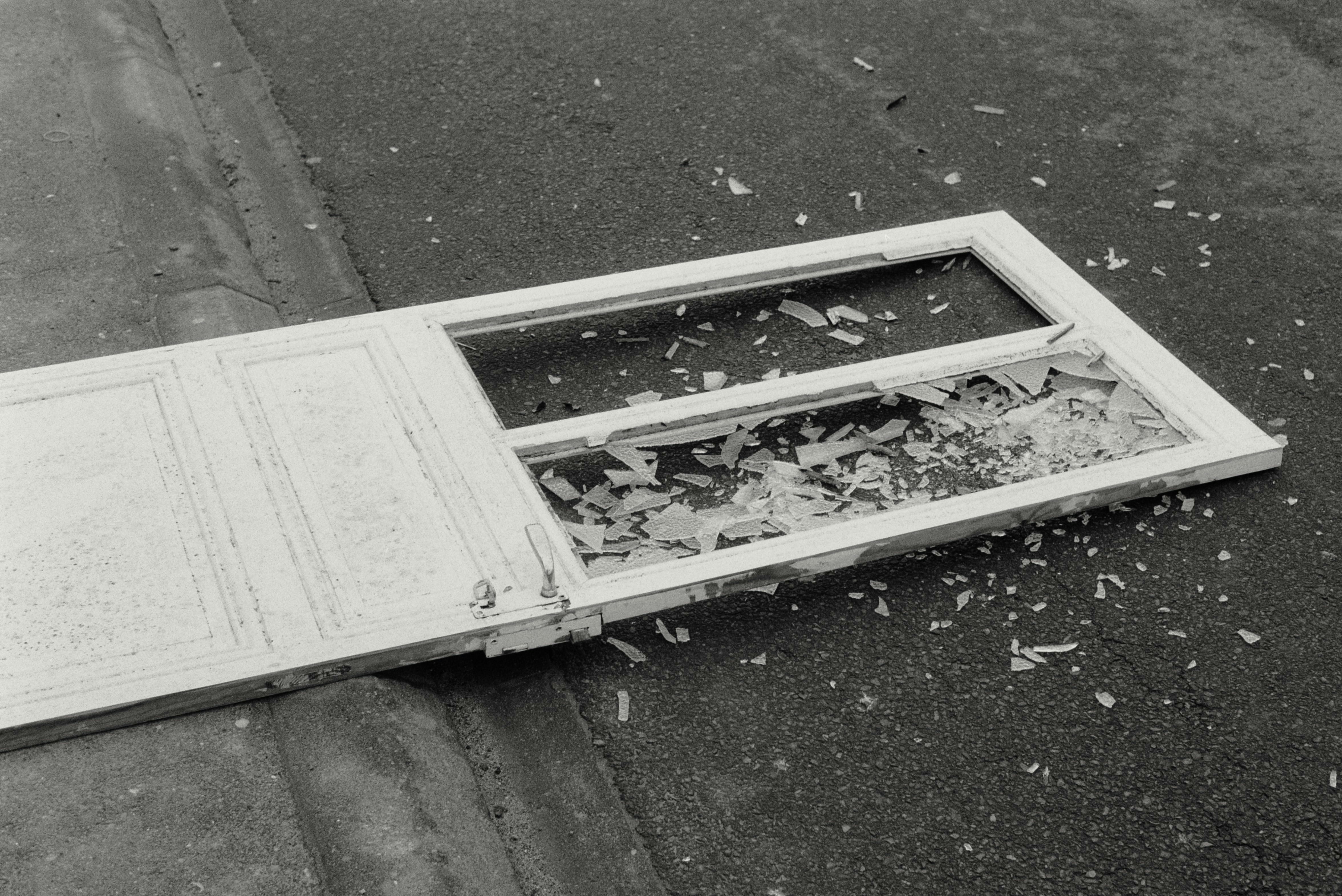 A broken window sitting on the side of a road photo – Free Construction ...