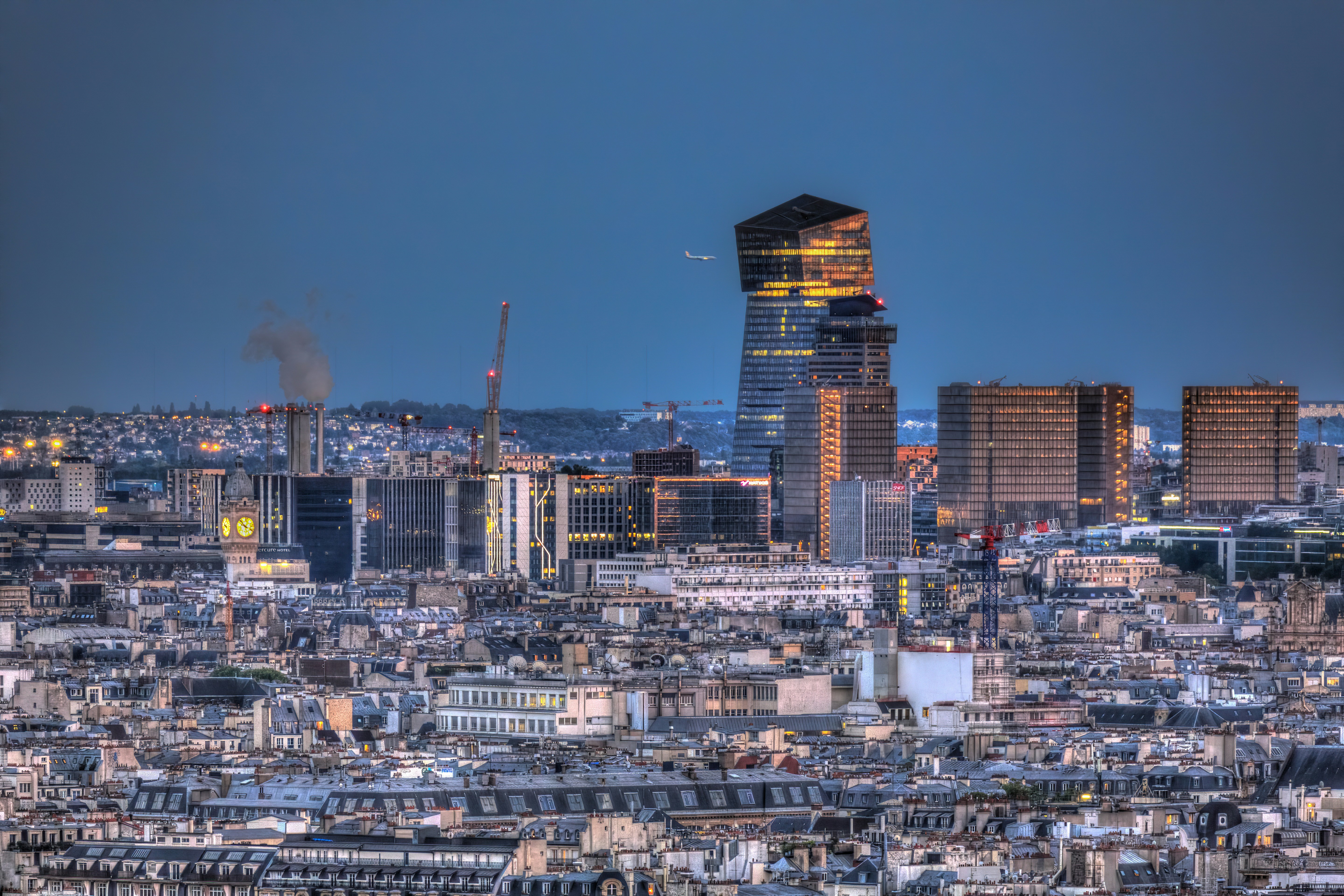 Skyscraper Crowned by Golden Windows Over a Distant City