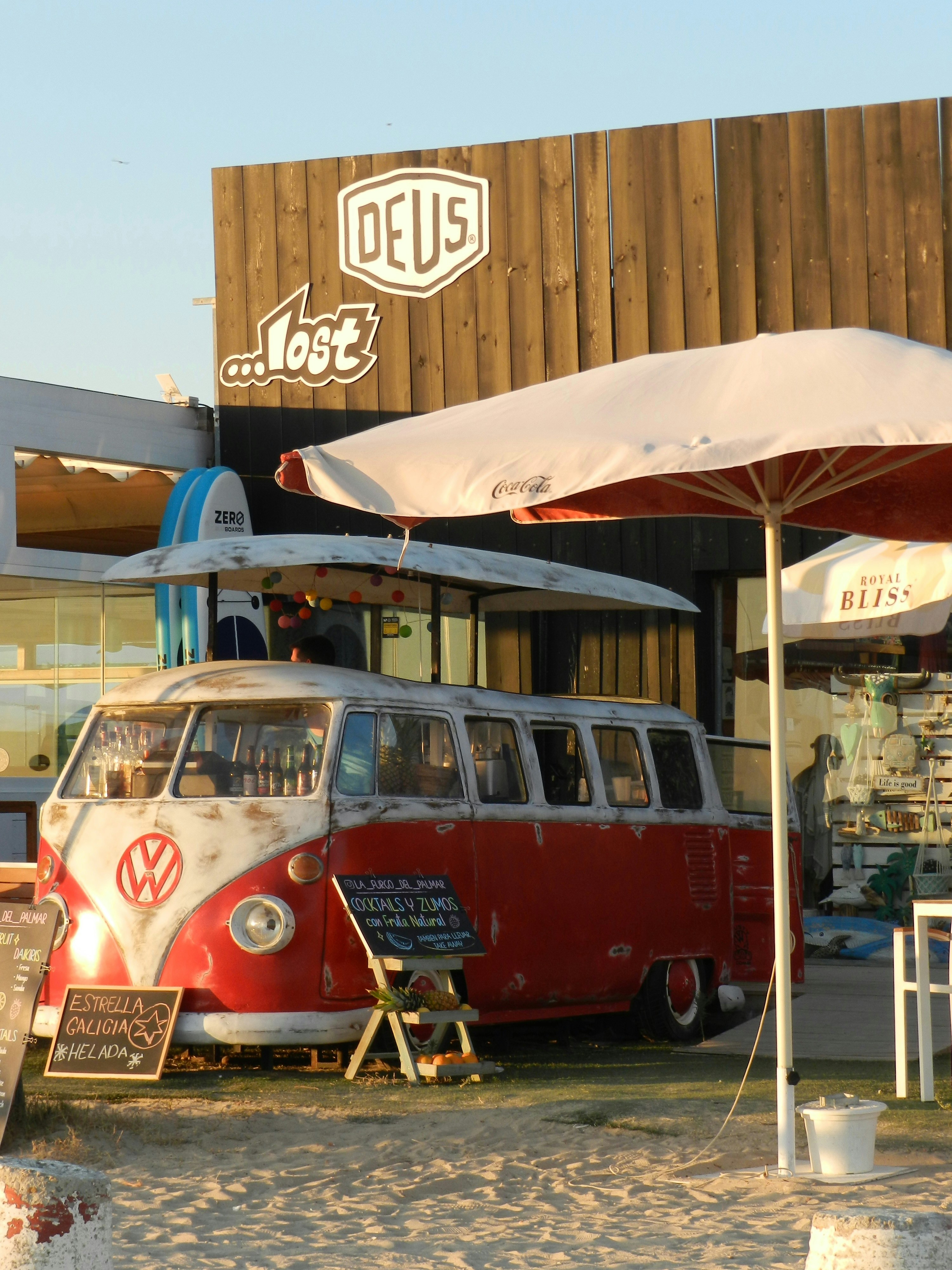 Retro VW Microbus Under Beachside Shade at a Sunny Boardwalk