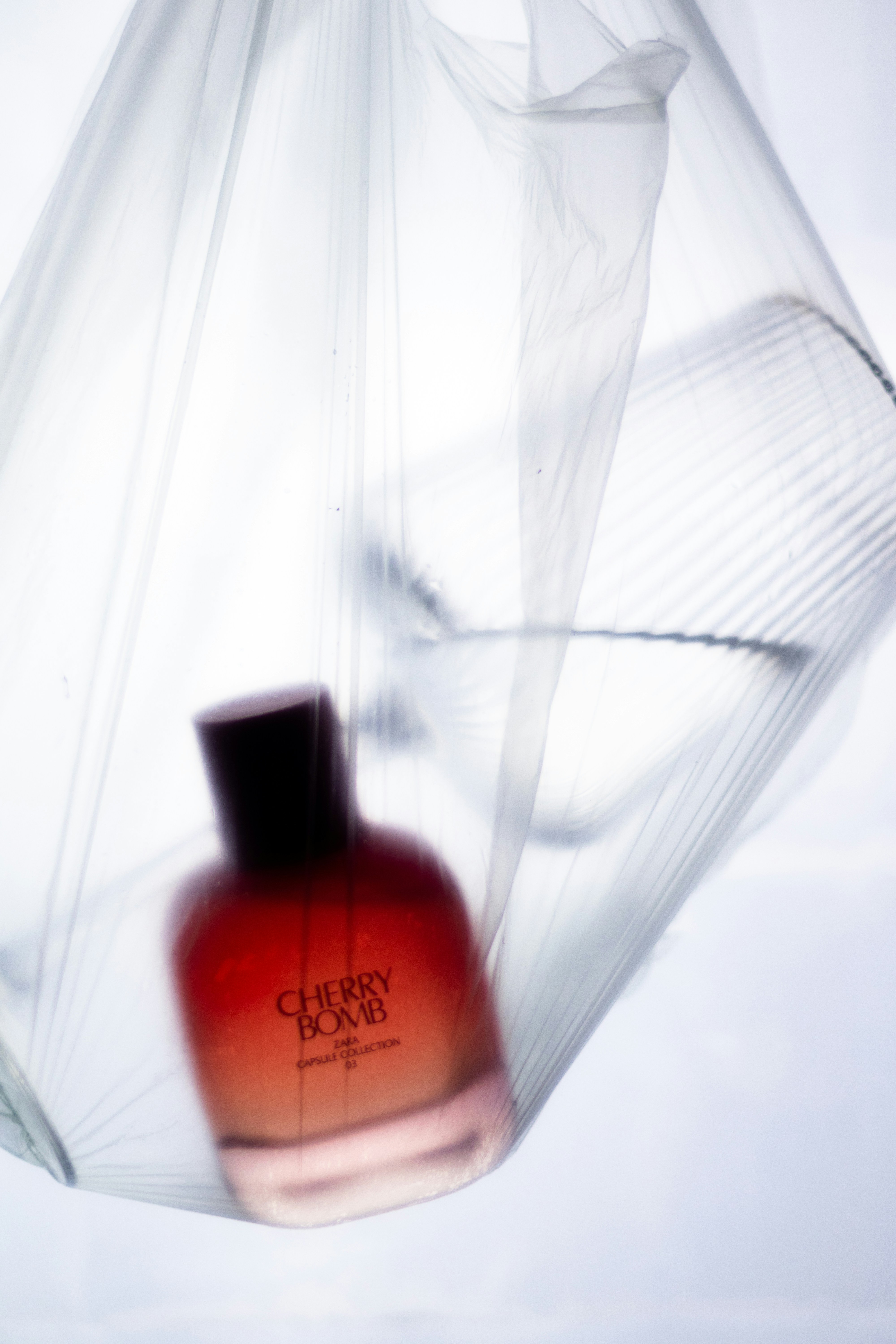 A bottle of perfume sitting in a clear bag