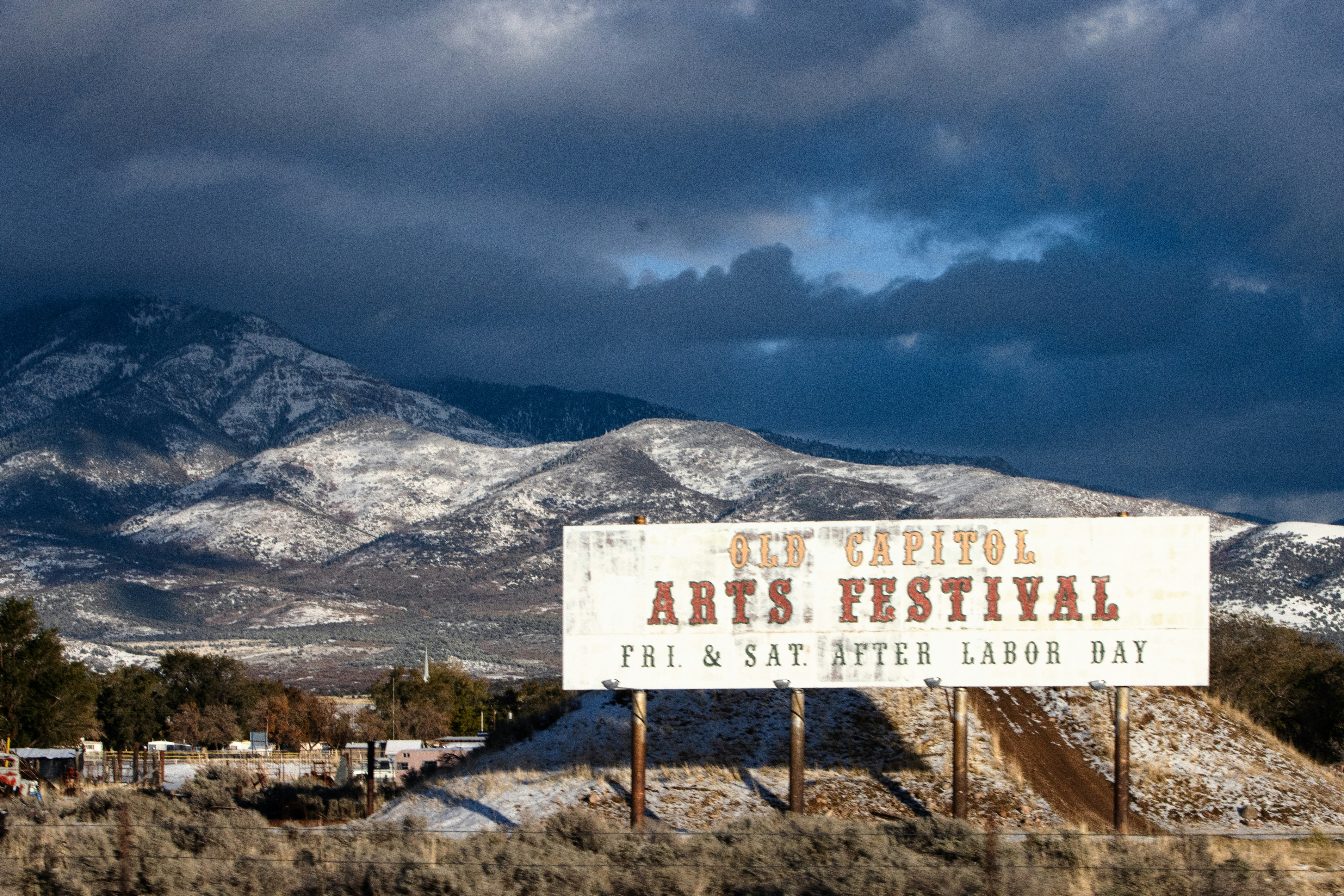 Desert Billboard Beyond Snow-dusted Ridge