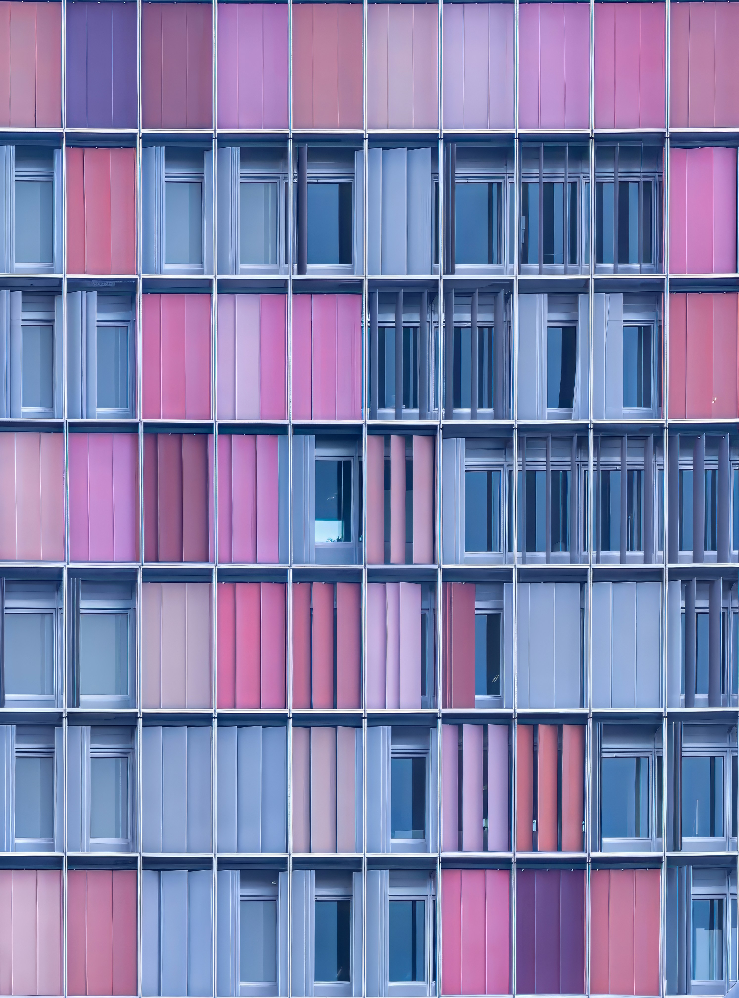 A multicolored building with lots of windows photo – Free Abstract ...