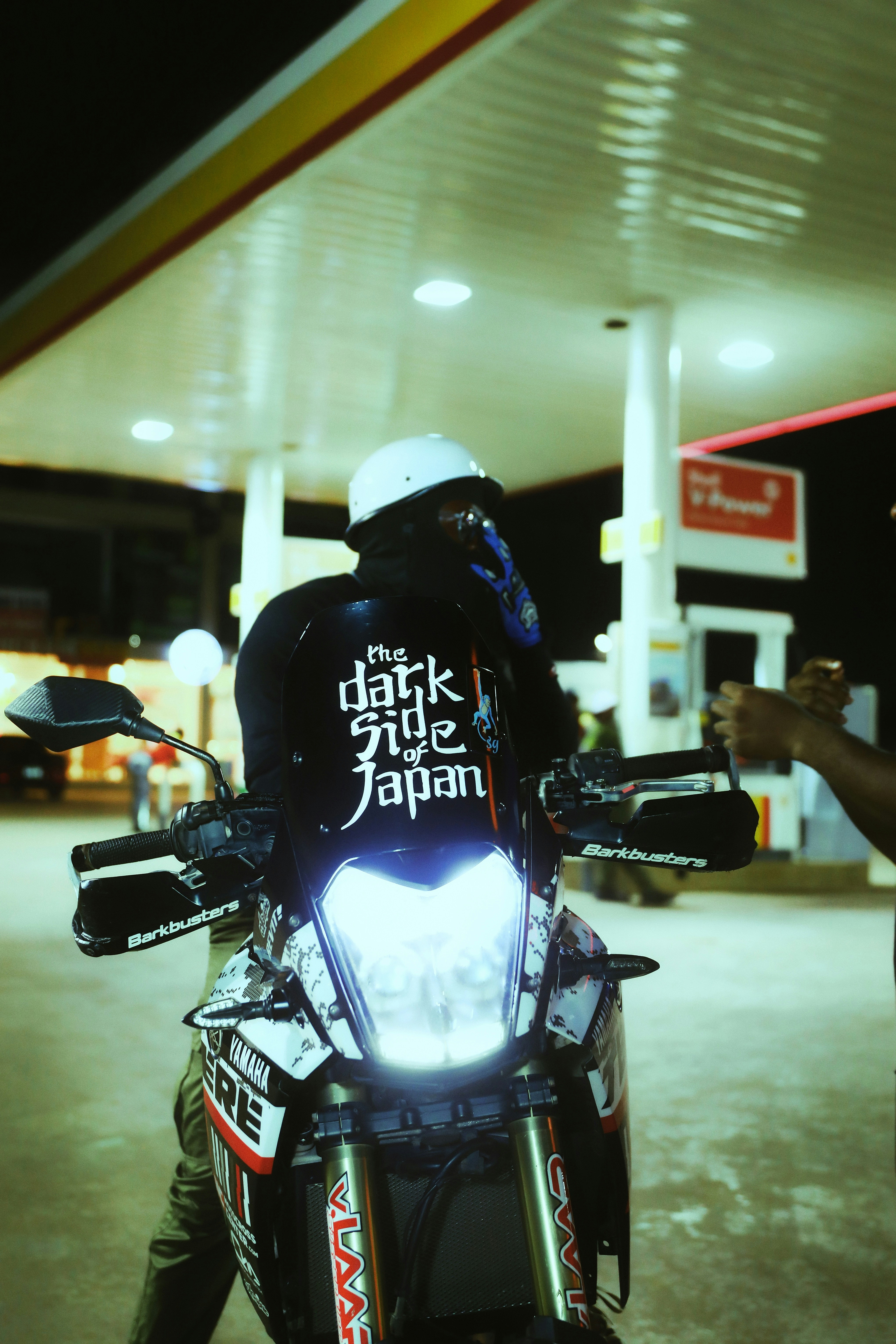 The Dark Side of Japan: Neon Headlights at a Midnight Gas Station