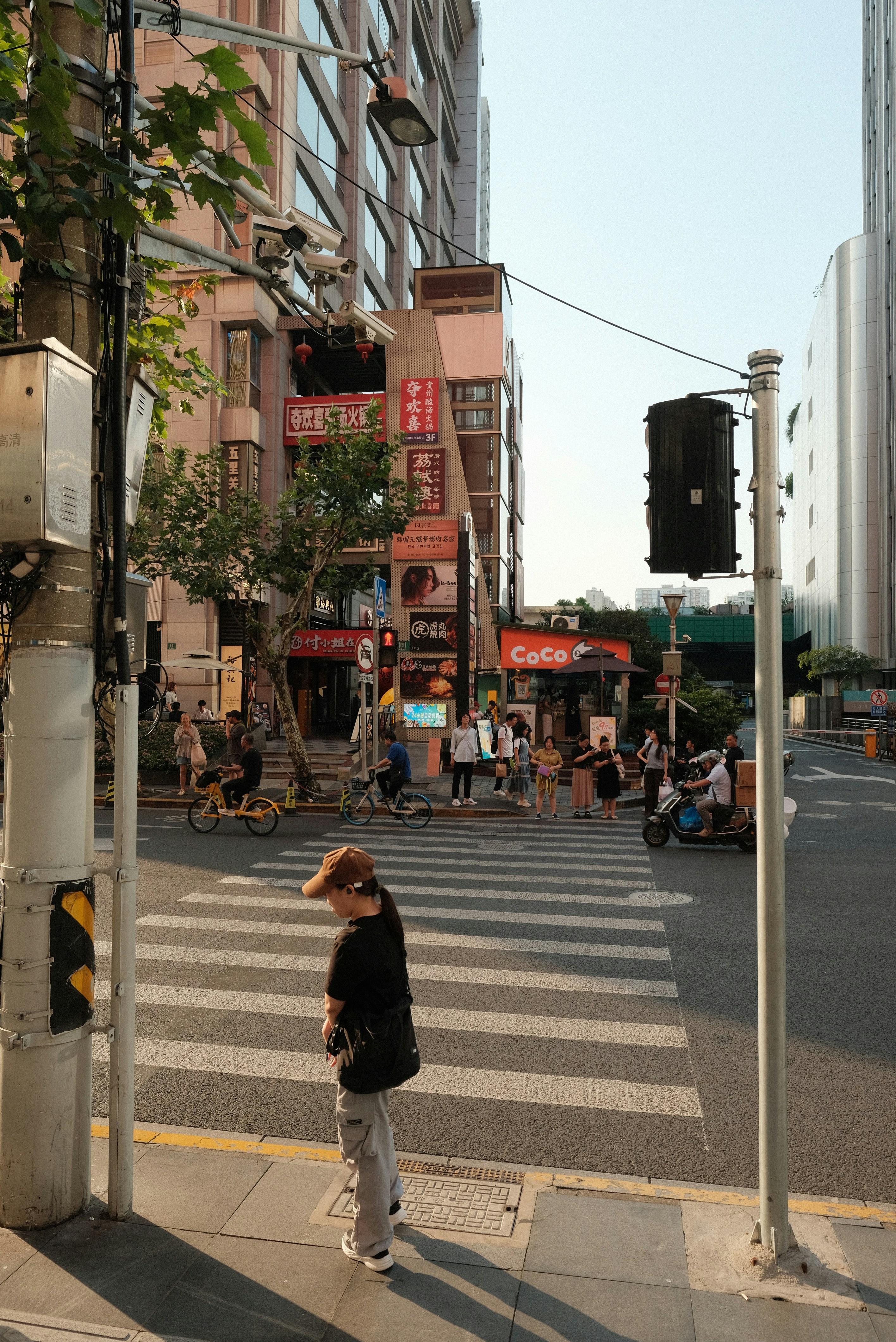 Sunlit Crosswalk: A Solo Traveler Amid City Pulse