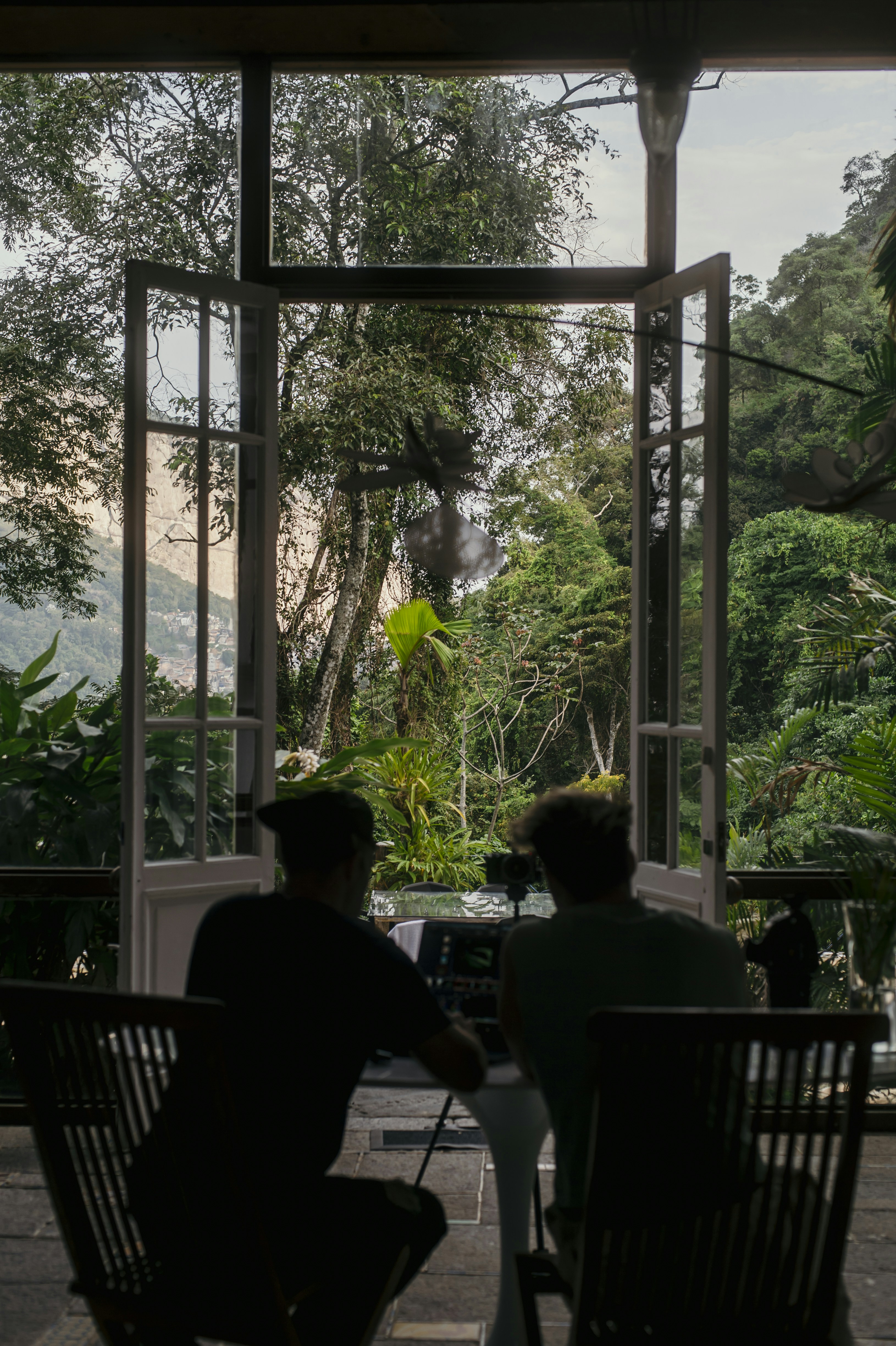 Two people sitting at a table in front of a window