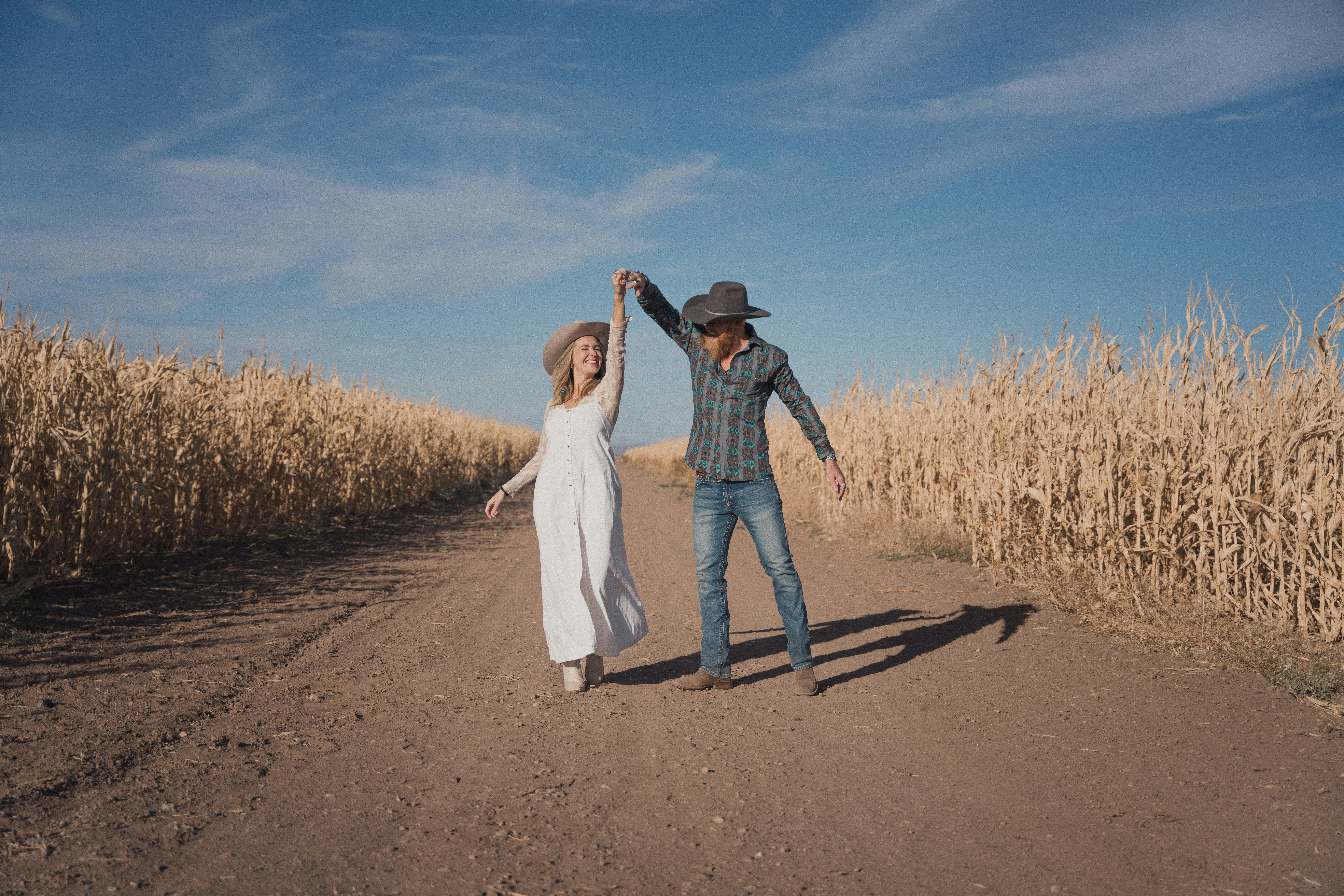 Dancing Through the Field: A Couple's Golden Hour Spin