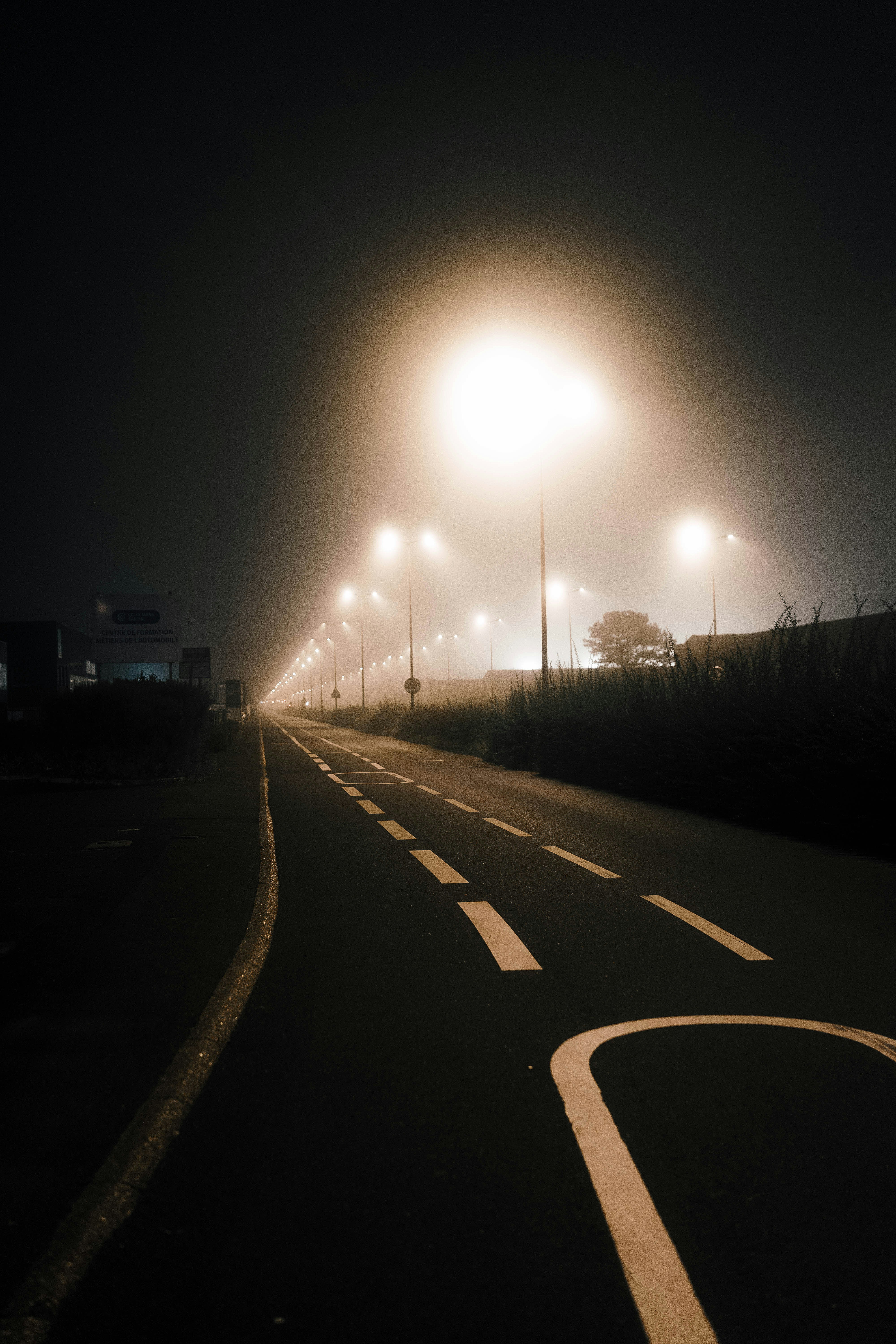 A foggy street at night with street lights photo – Free Road Image on ...