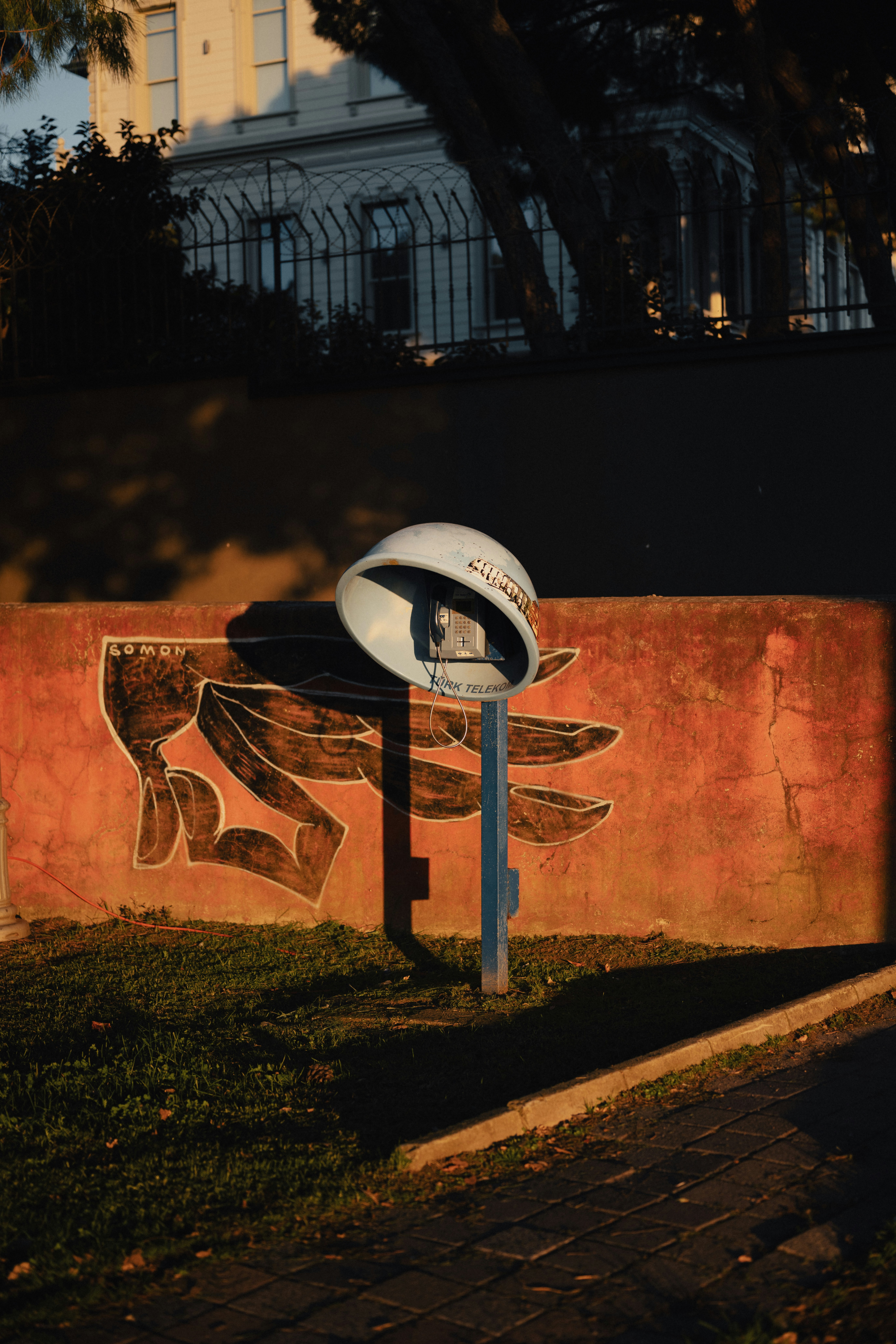 Dome Sentinel in Golden Hour: Graffiti Wall and Shadow