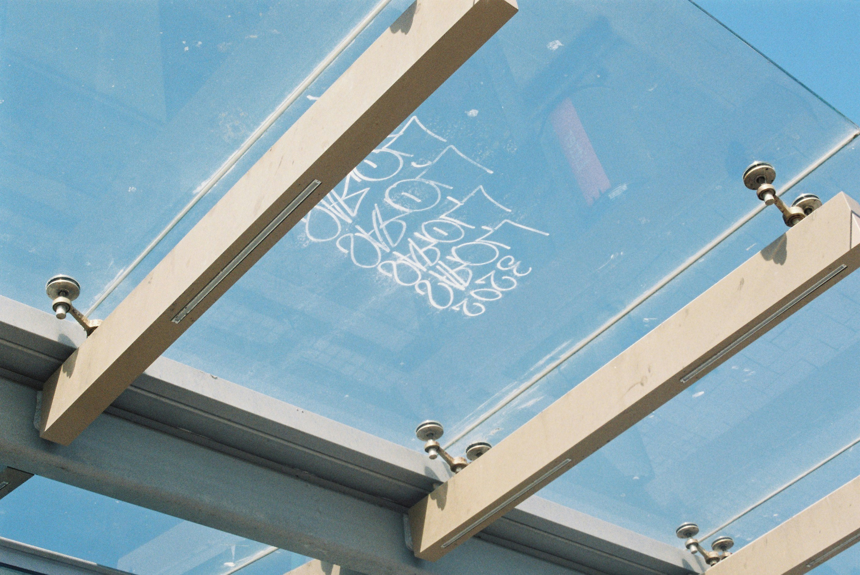 Graffiti on a Glass Canopy: A Sky-Blue Framework