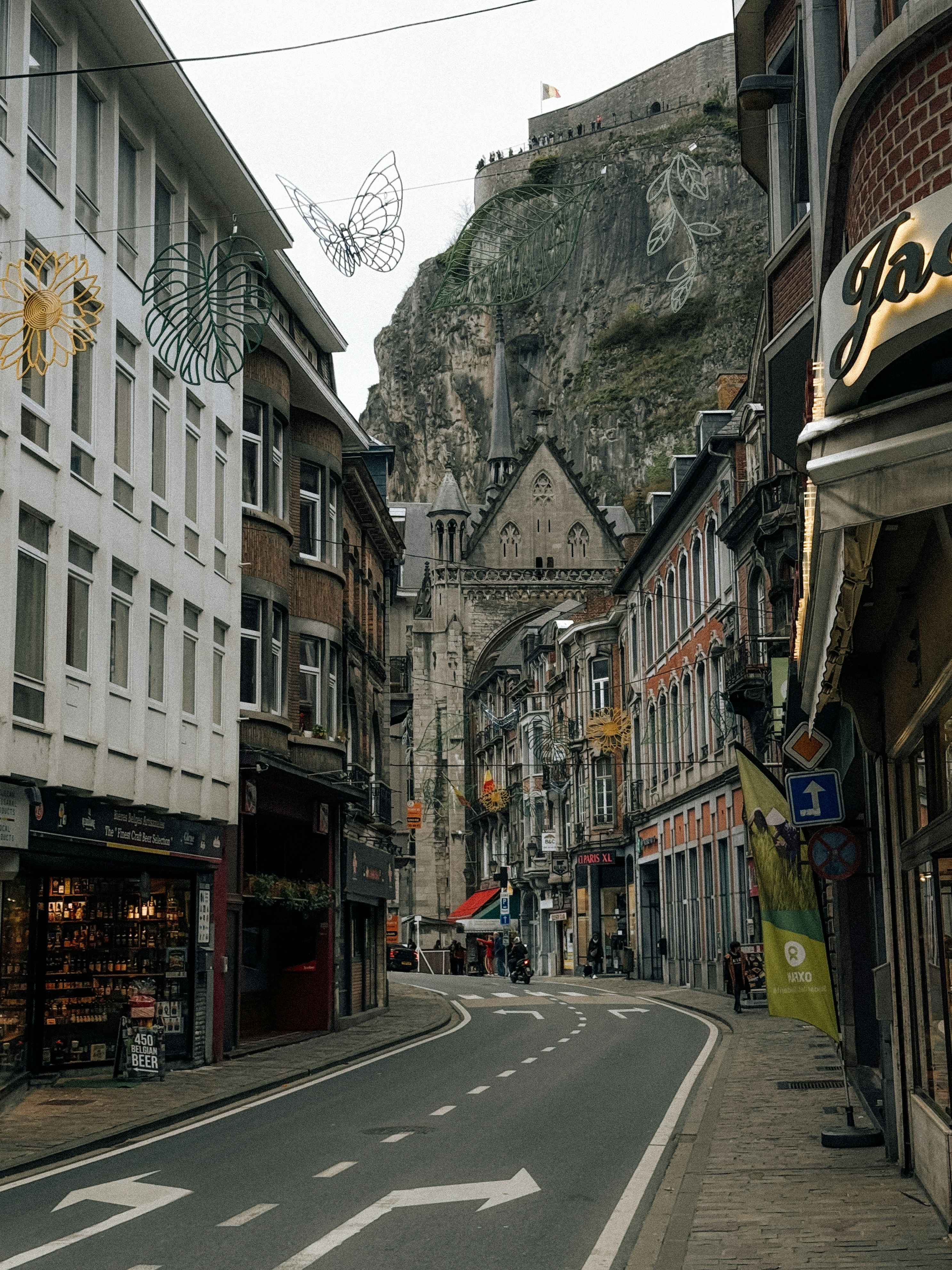 Cathedral at the Street's End: A Medieval Corridor Framed by Butterflies and Cliff
