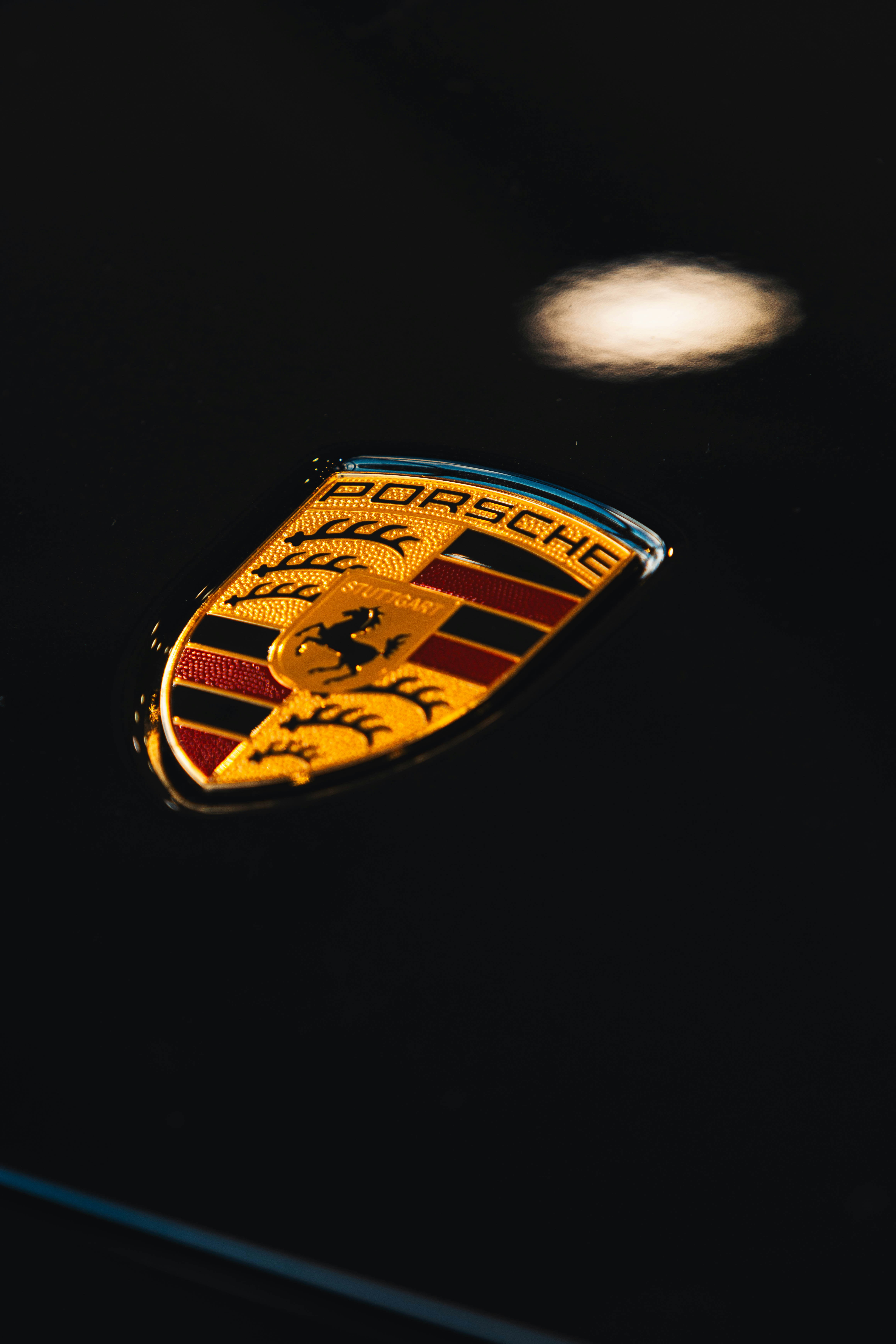 Emblem of Speed: Porsche Crest Adorned on a Midnight Hood