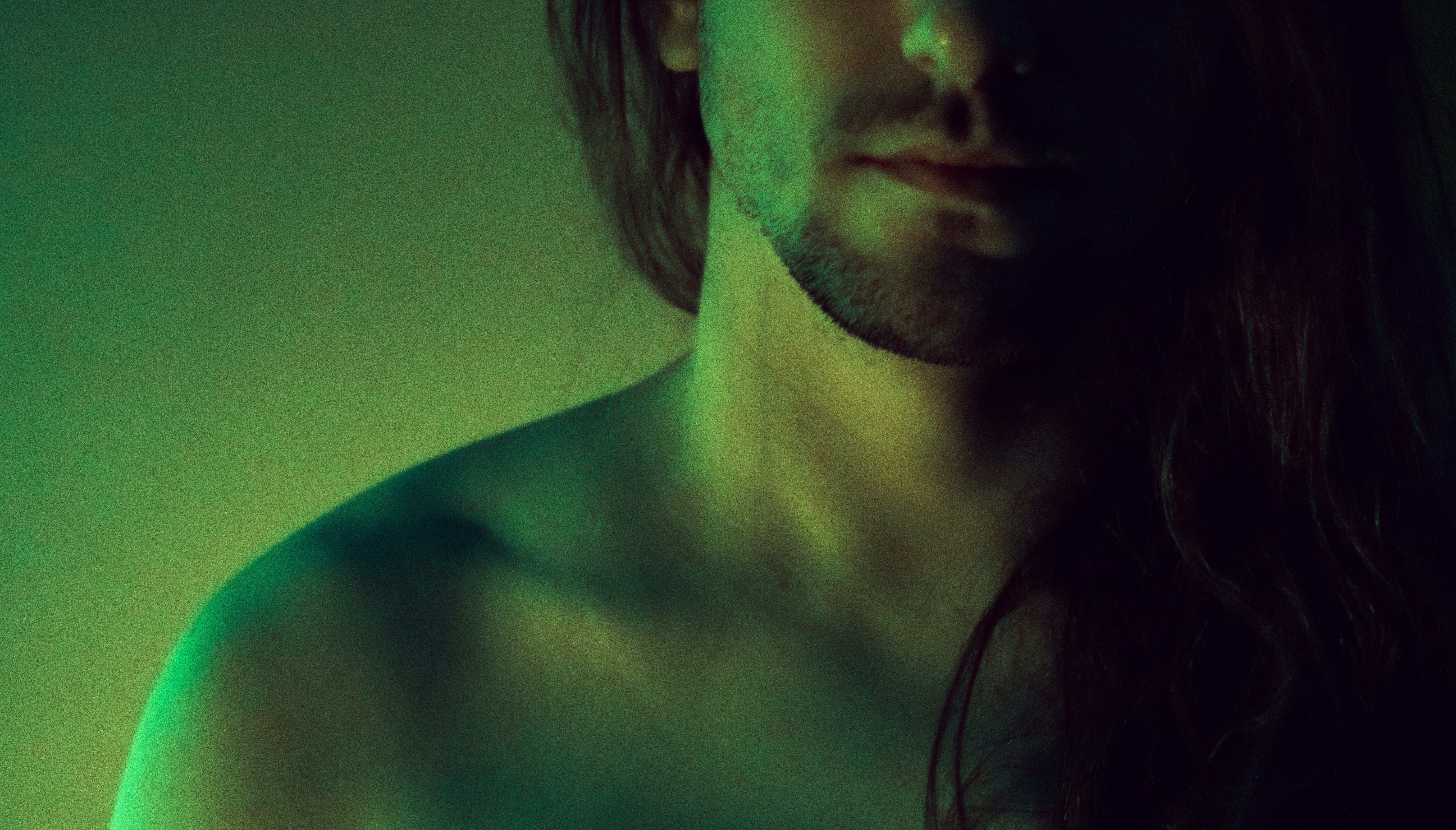 Emerald Veil: A Half-Lit Portrait Beneath Neon Green Light
