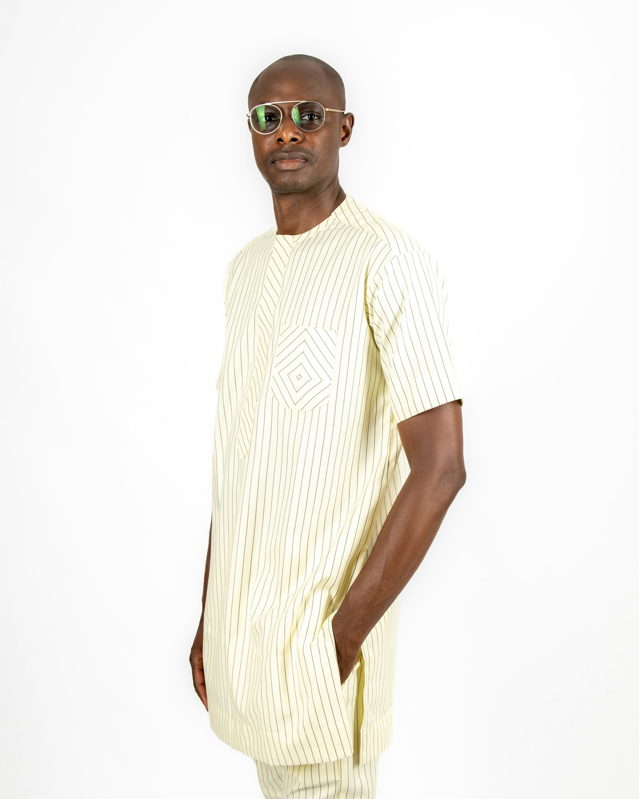 Cream-Striped Confidence: A Studio Portrait with Minimal Backdrop