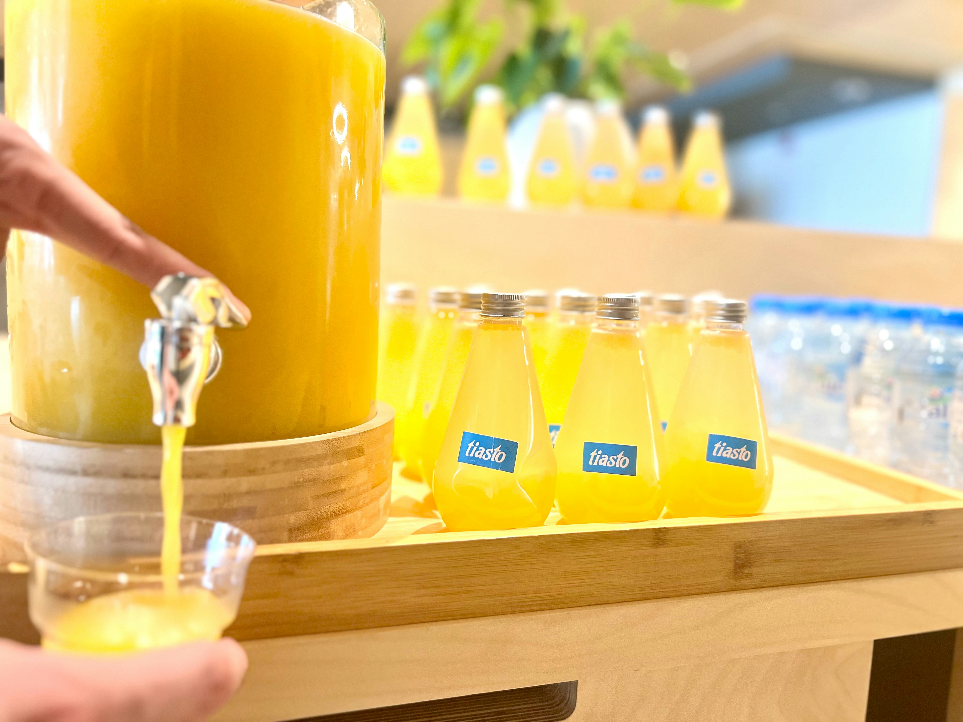 Juice Fountain at Dawn: A Bright Pour Amid Bottled Sunshine