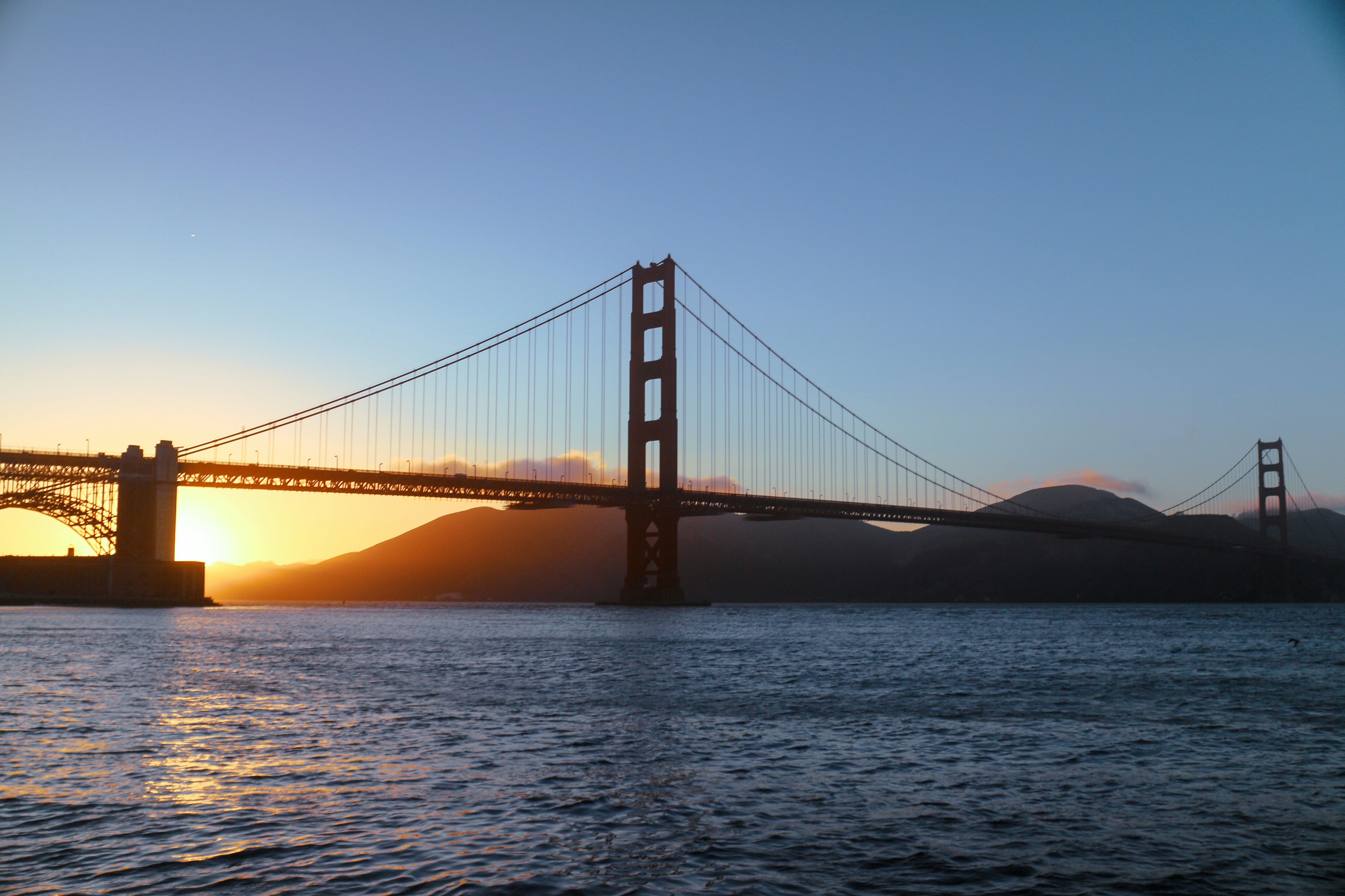 The golden gate bridge at sunset as seen from a boat photo – Free ...