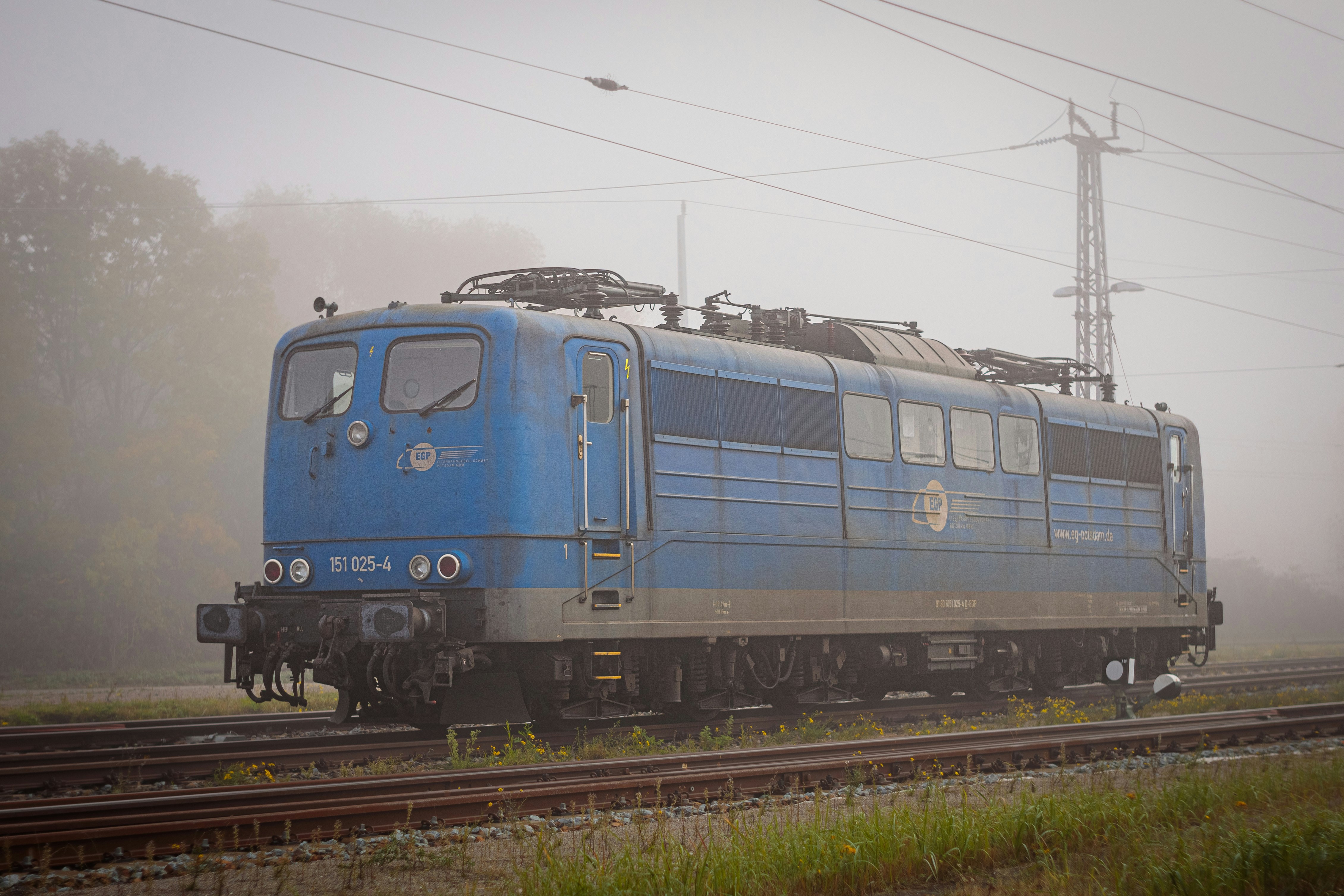 Mist-Quiet Blue Diesel-Electric Locomotive on Damp Tracks