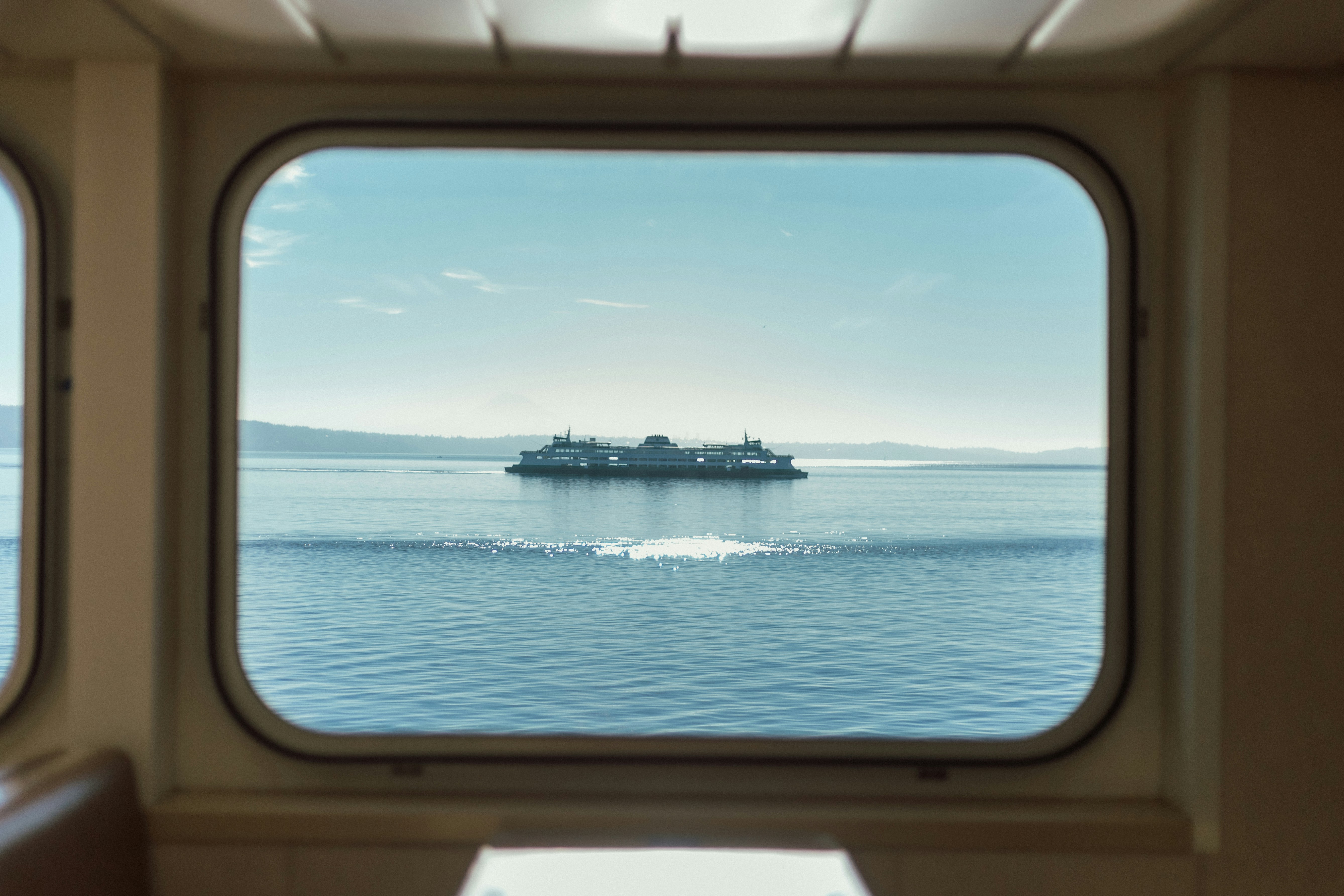 Frame Within a Frame: A Distant Ferry Skimming the Calm Blue Sea
