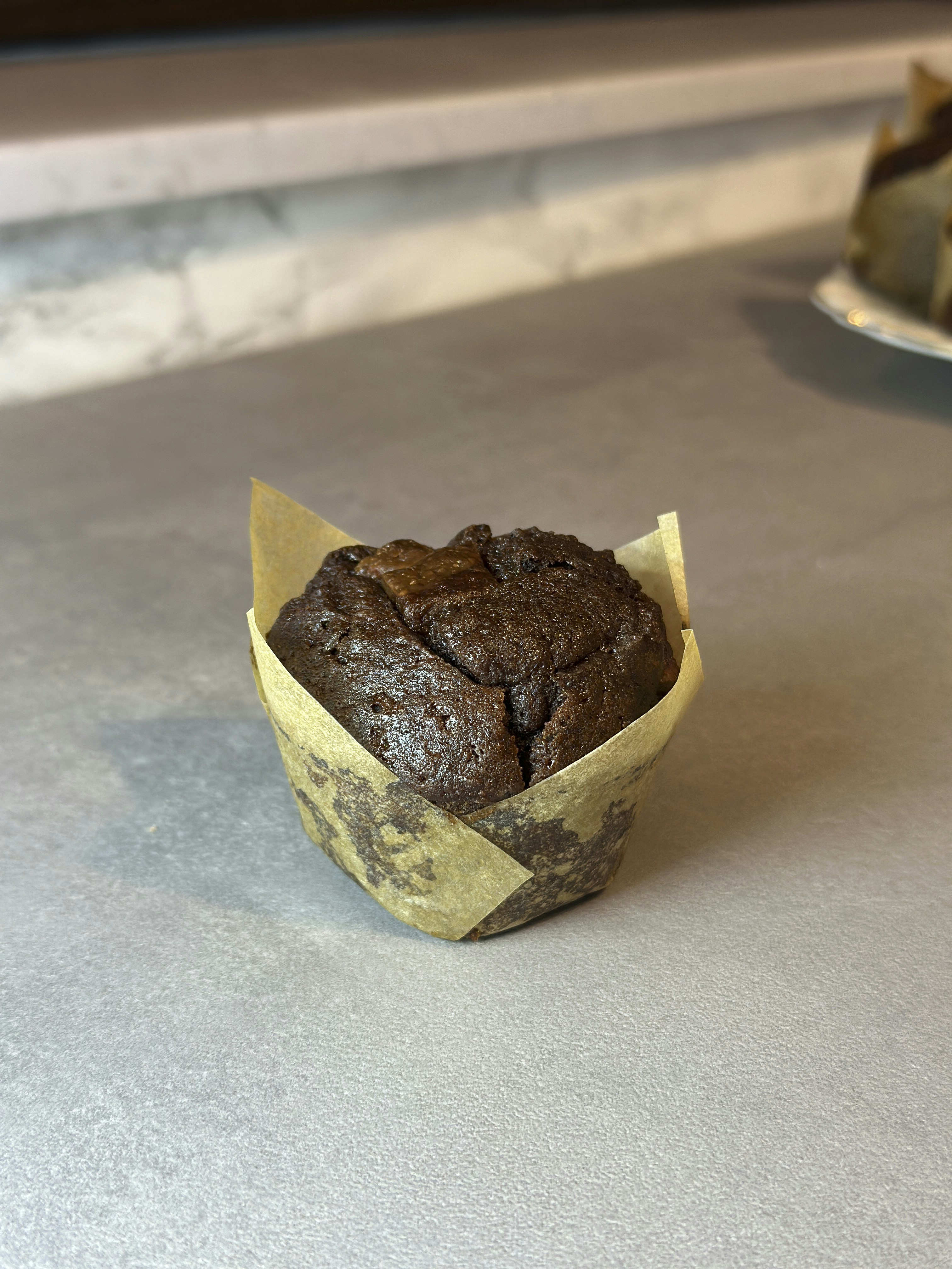 A muffin sitting on top of a counter next to another muffin photo ...