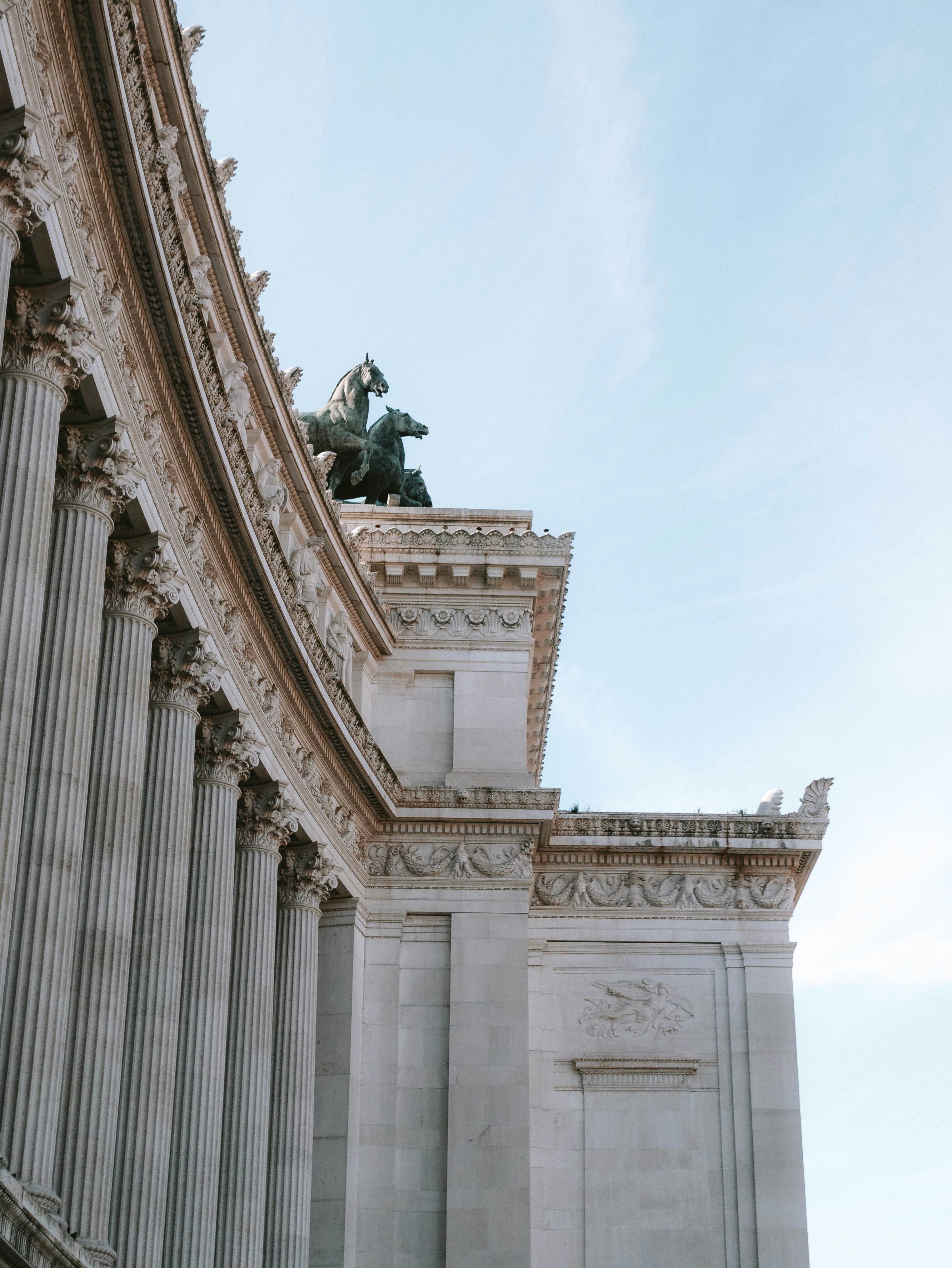 A tall building with a statue on top of it photo – Free Rome Image on ...