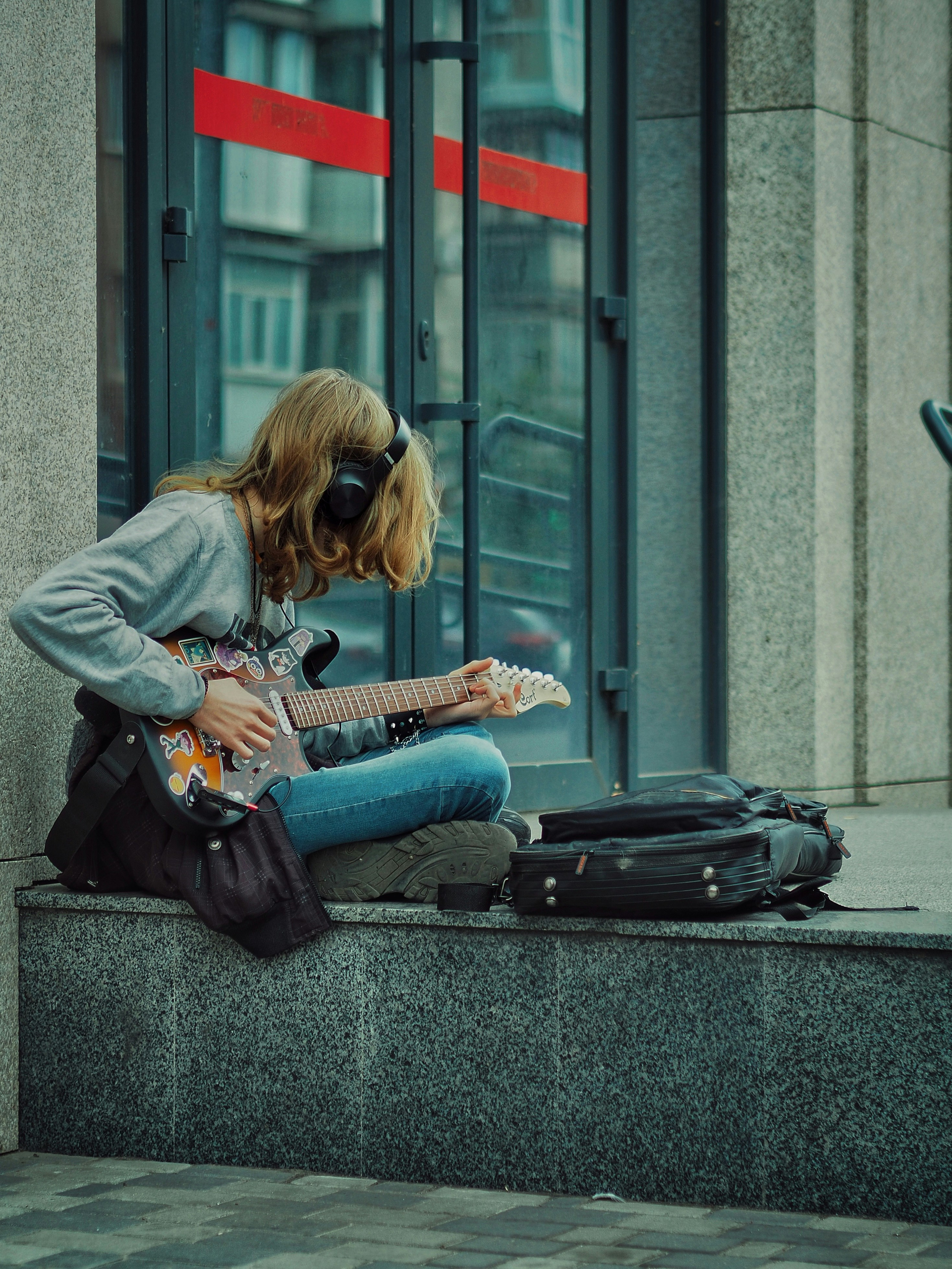 Strumming Solitude: A Melodic Moment on the Streets