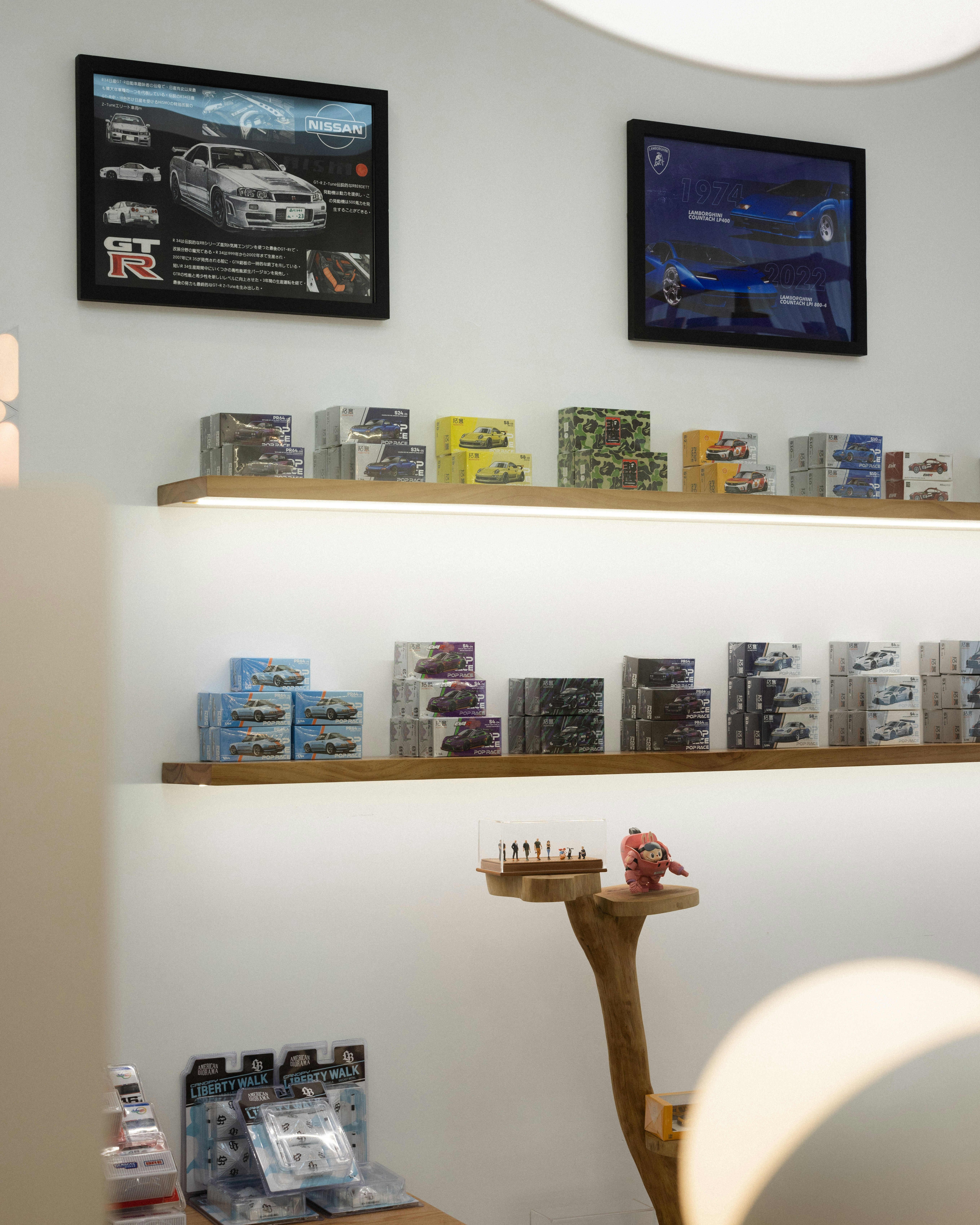 Colorful Miniature Car Boxes Align on Warmly Lit Shelves