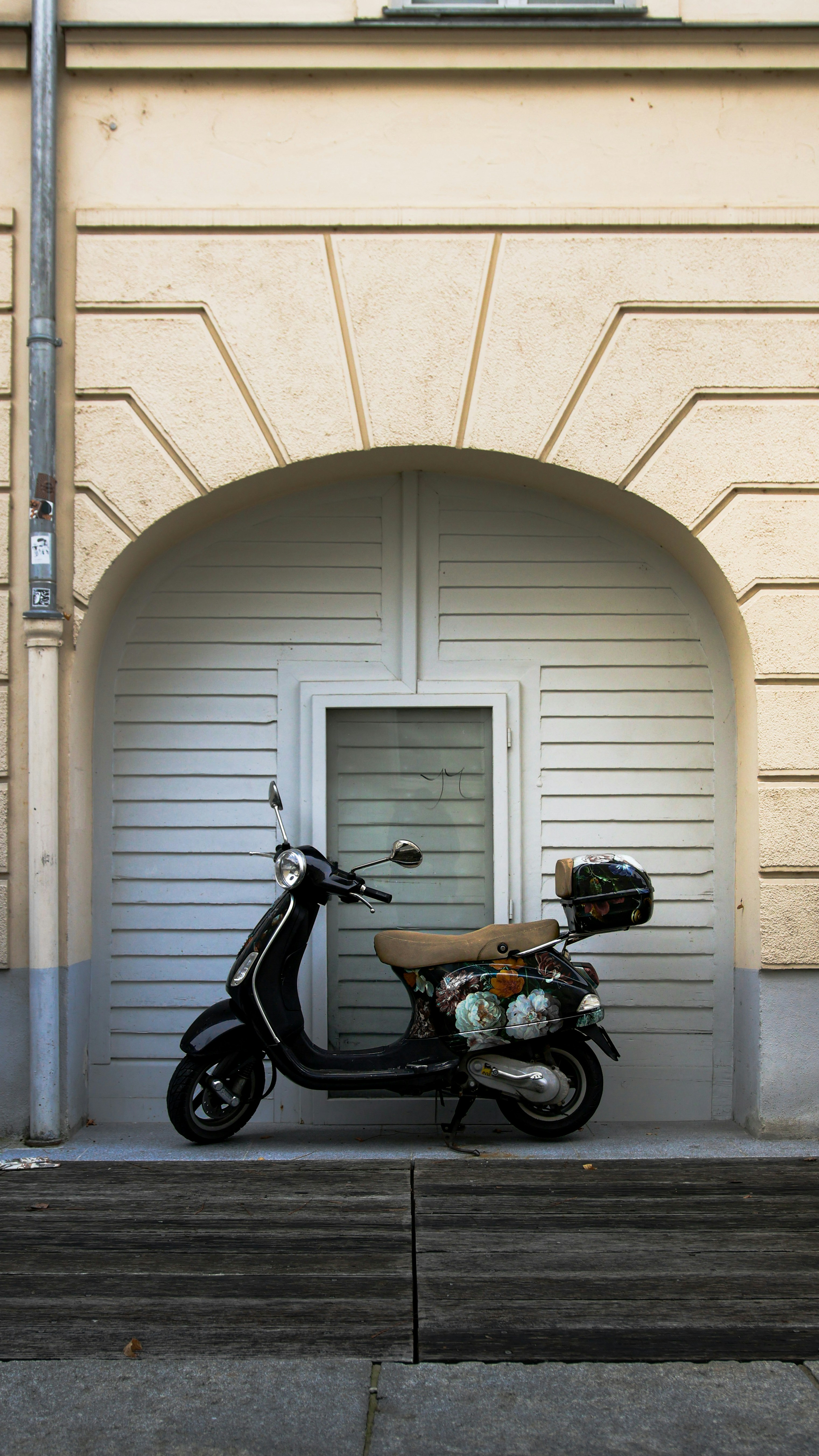 Floral-Wrapped Scooter Under a Pale Archway