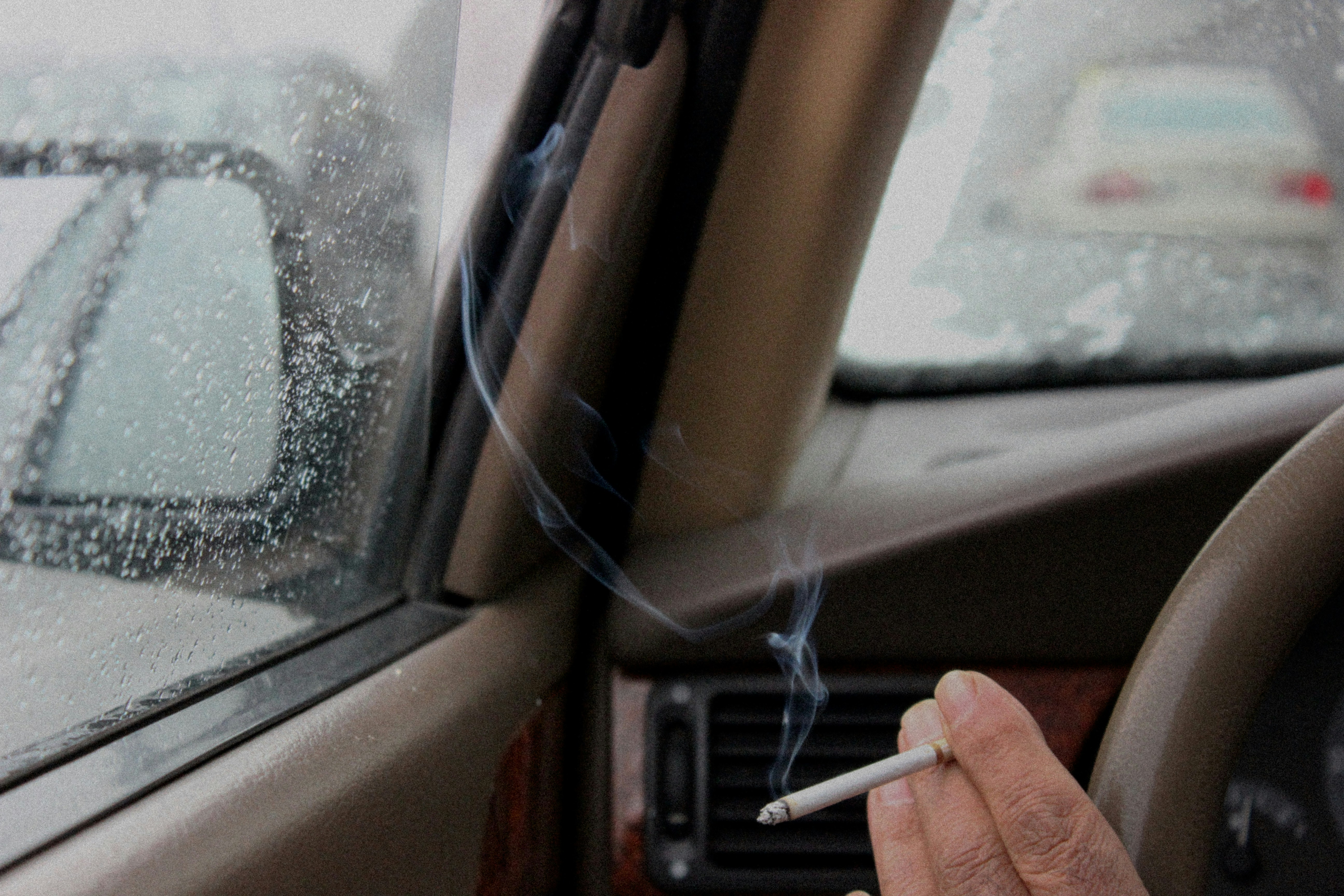 Ember at the Wheel in a Rain-Soaked Car