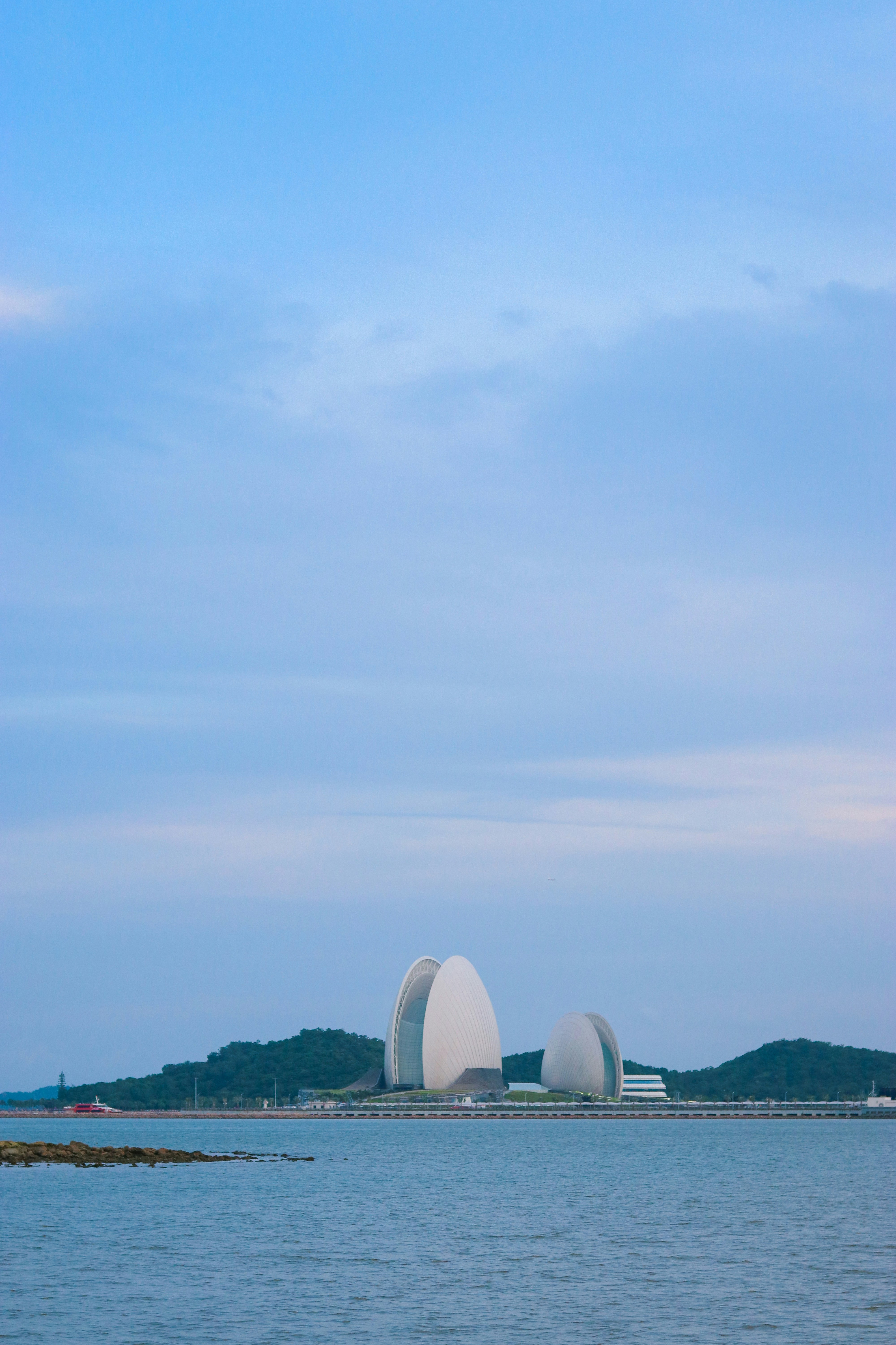 Oceanic Vista: The Sail-like Structures Rise from Quiet Waters