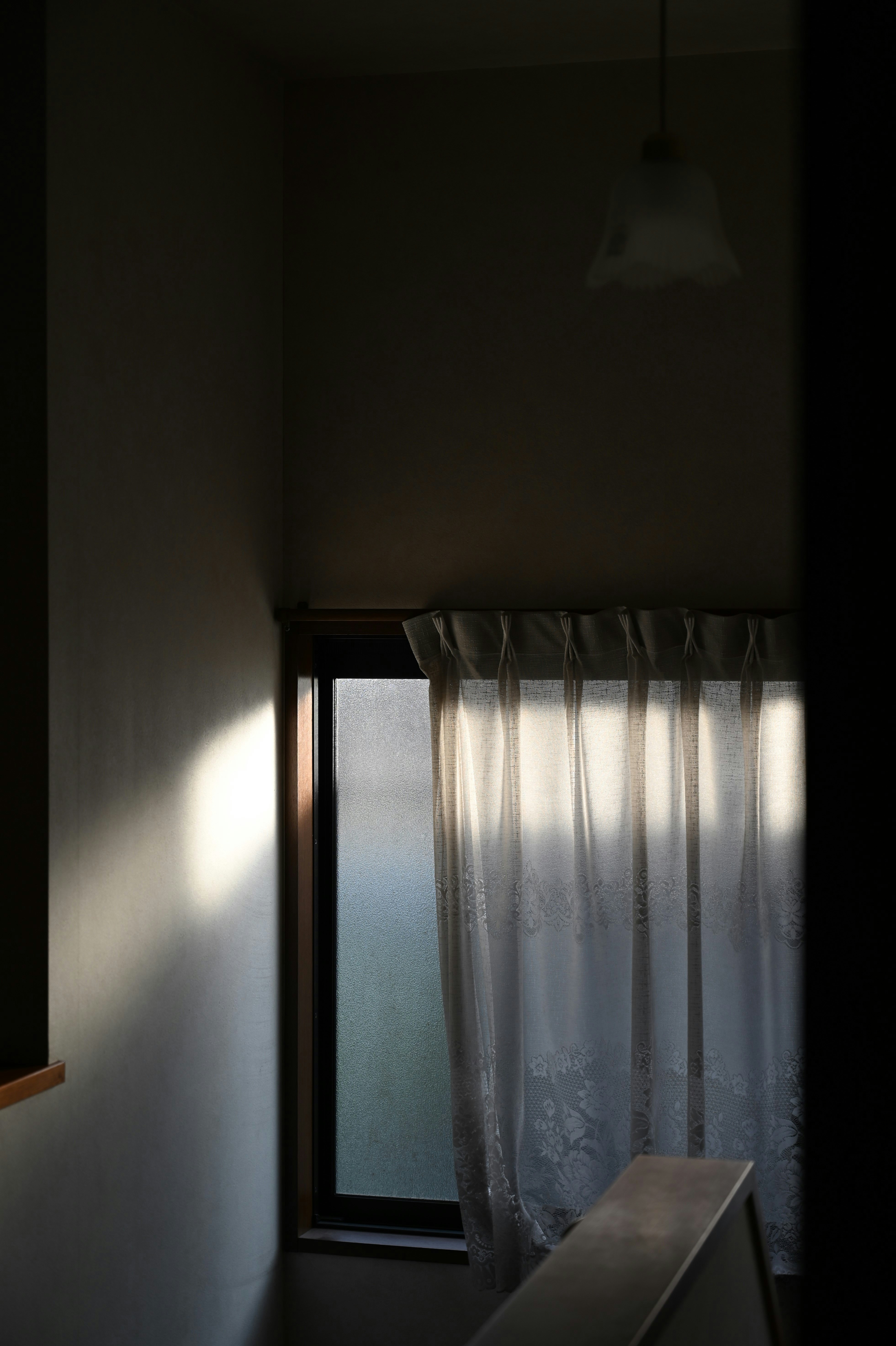 A dimly lit room with a window and a curtain photo – Free Window Image ...