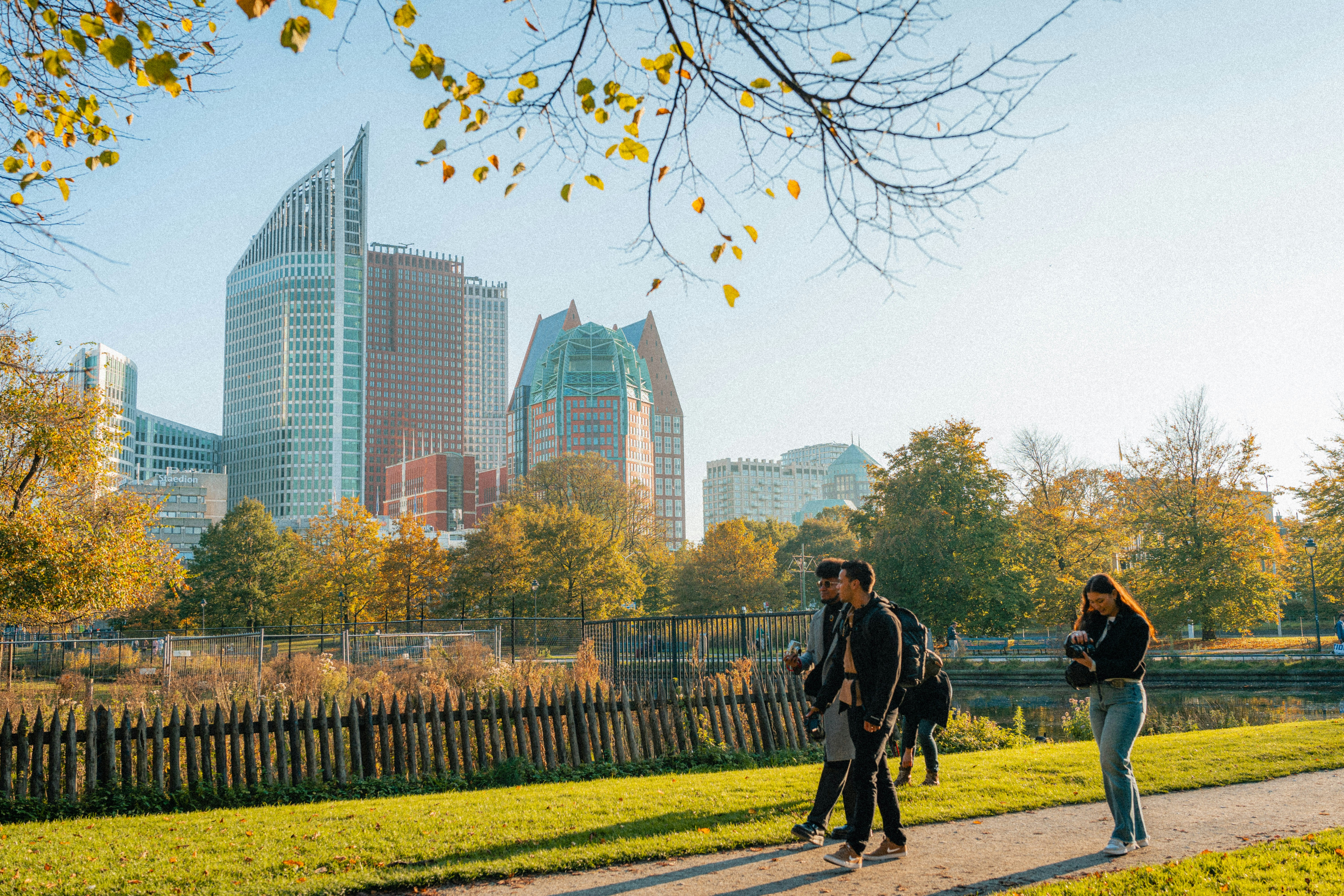 Golden Riverside Stroll: Autumn Light Framing the Downtown Skyline