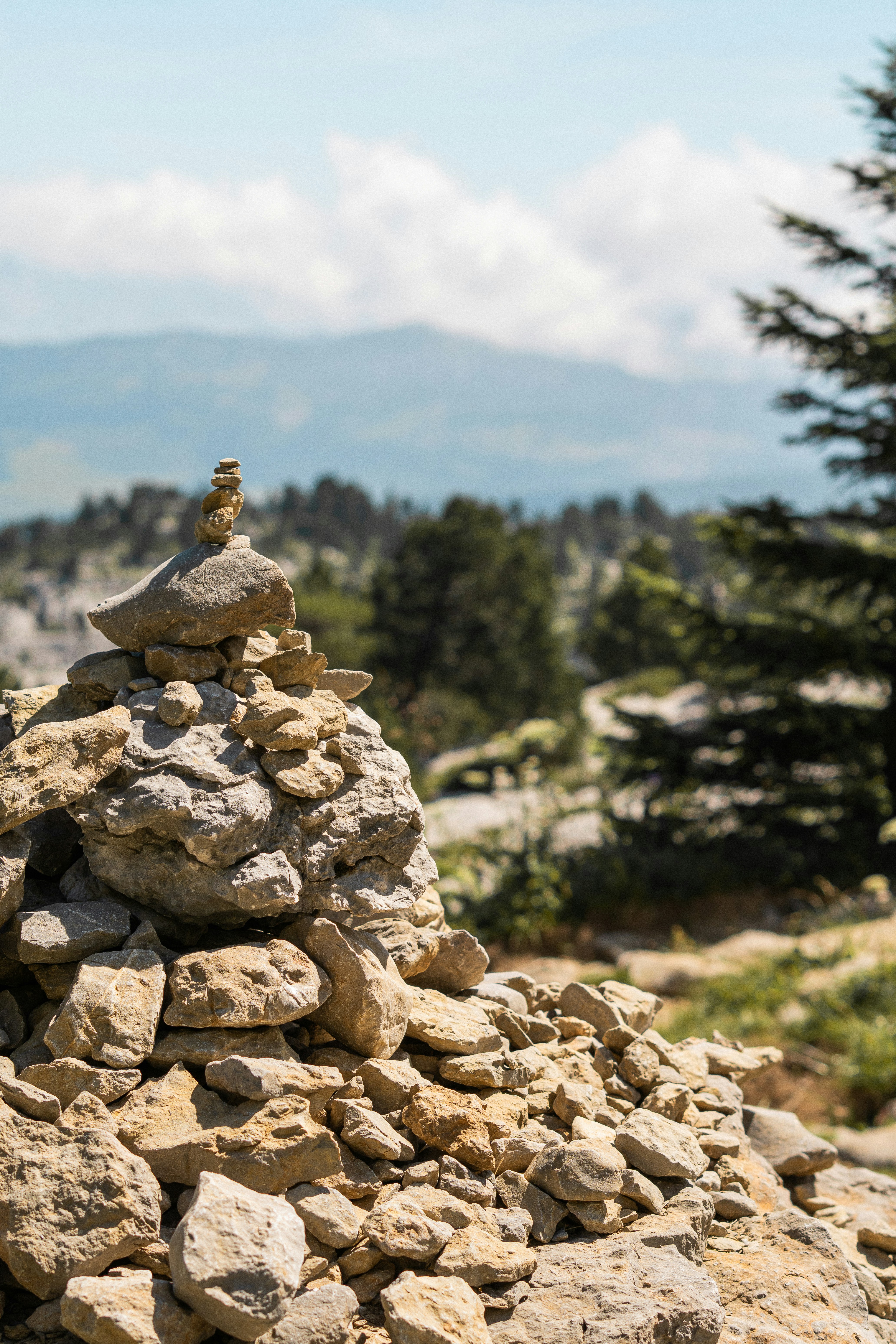 Cairn on the Ridge: Stones in a Sunlit Alpine Scene