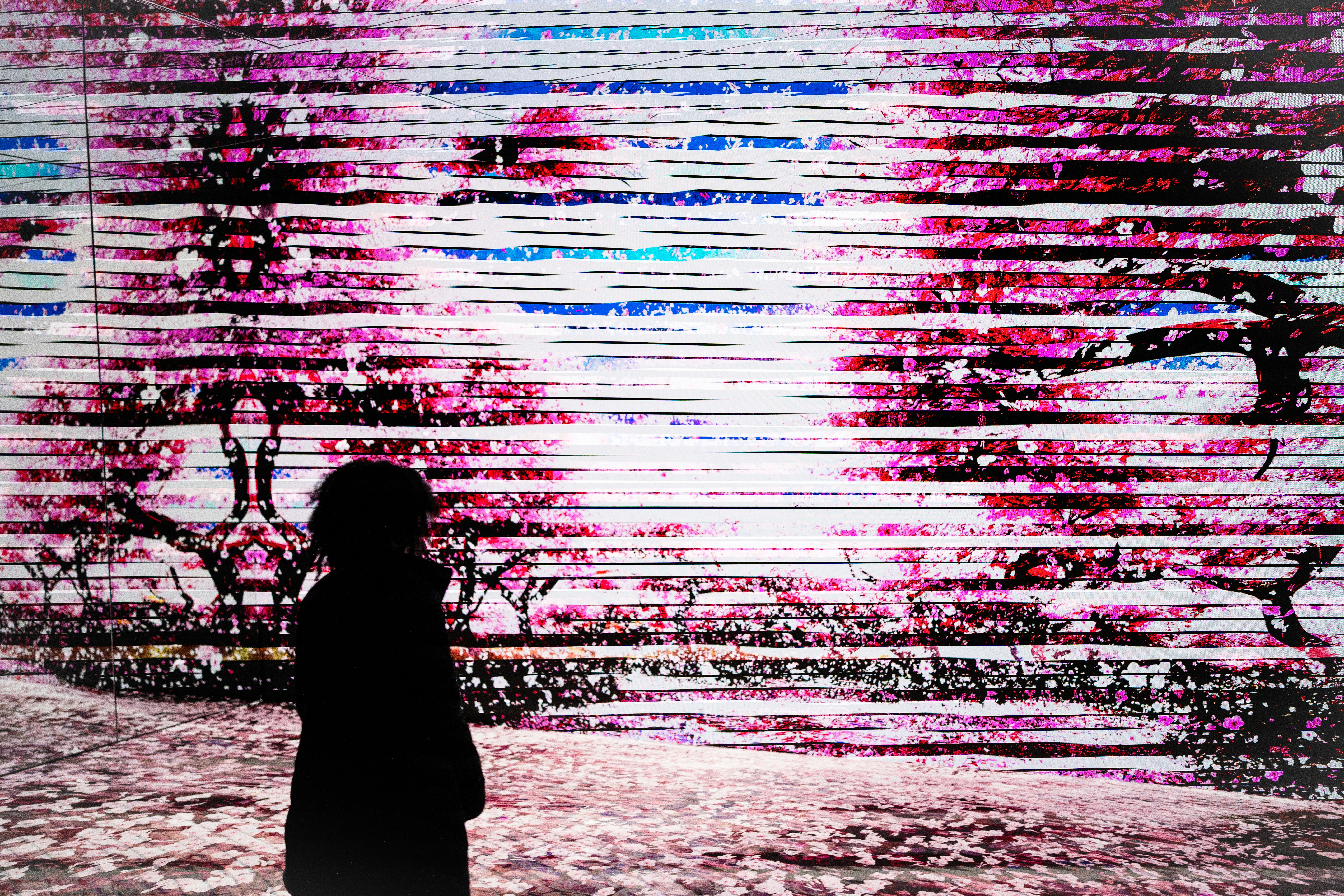 Neon silhouette: a lone observer against a hypnotic graffiti horizon