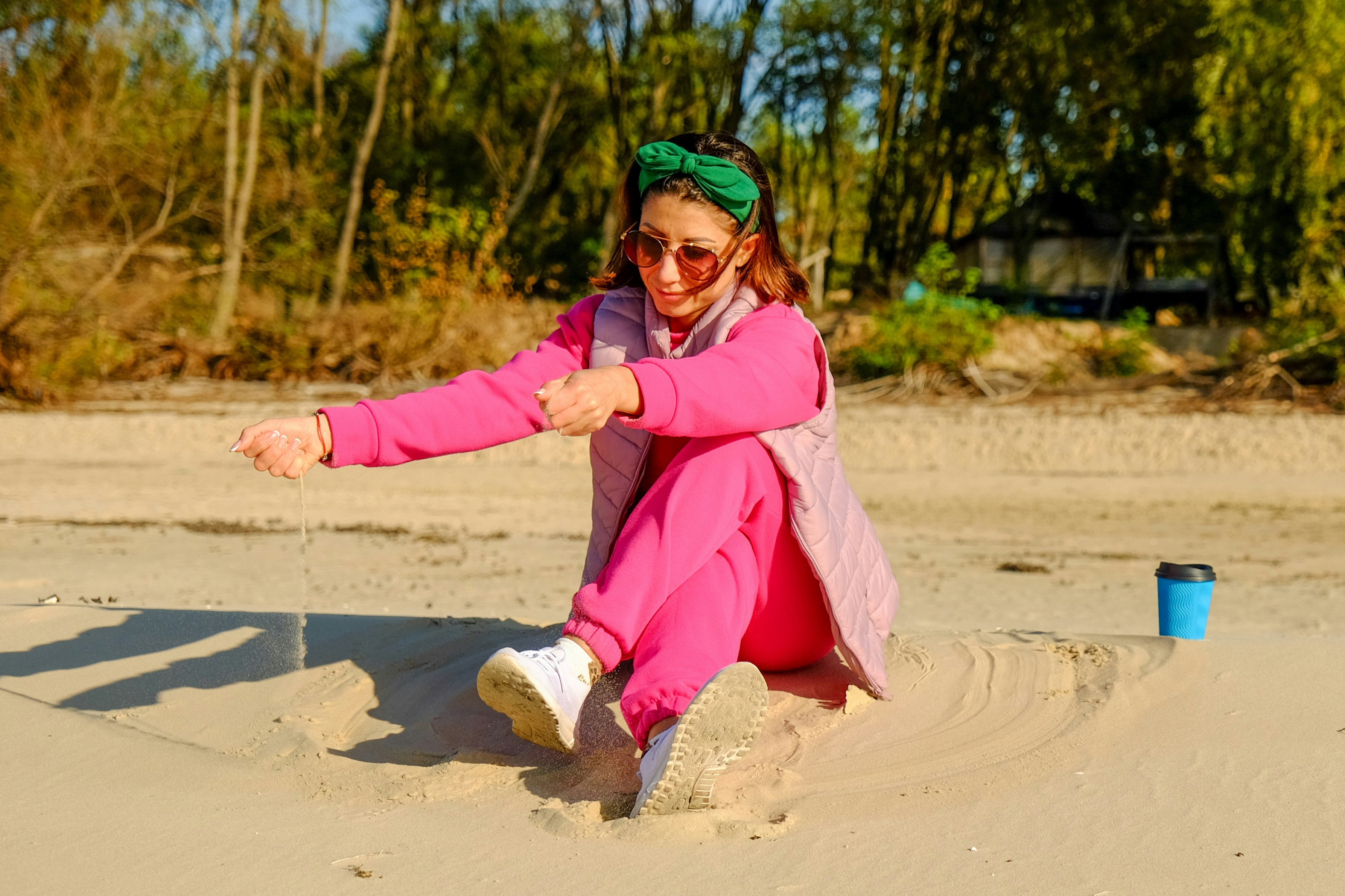 Beach-side Kickoff: A Girl in Pink Finds Joy in the Sand