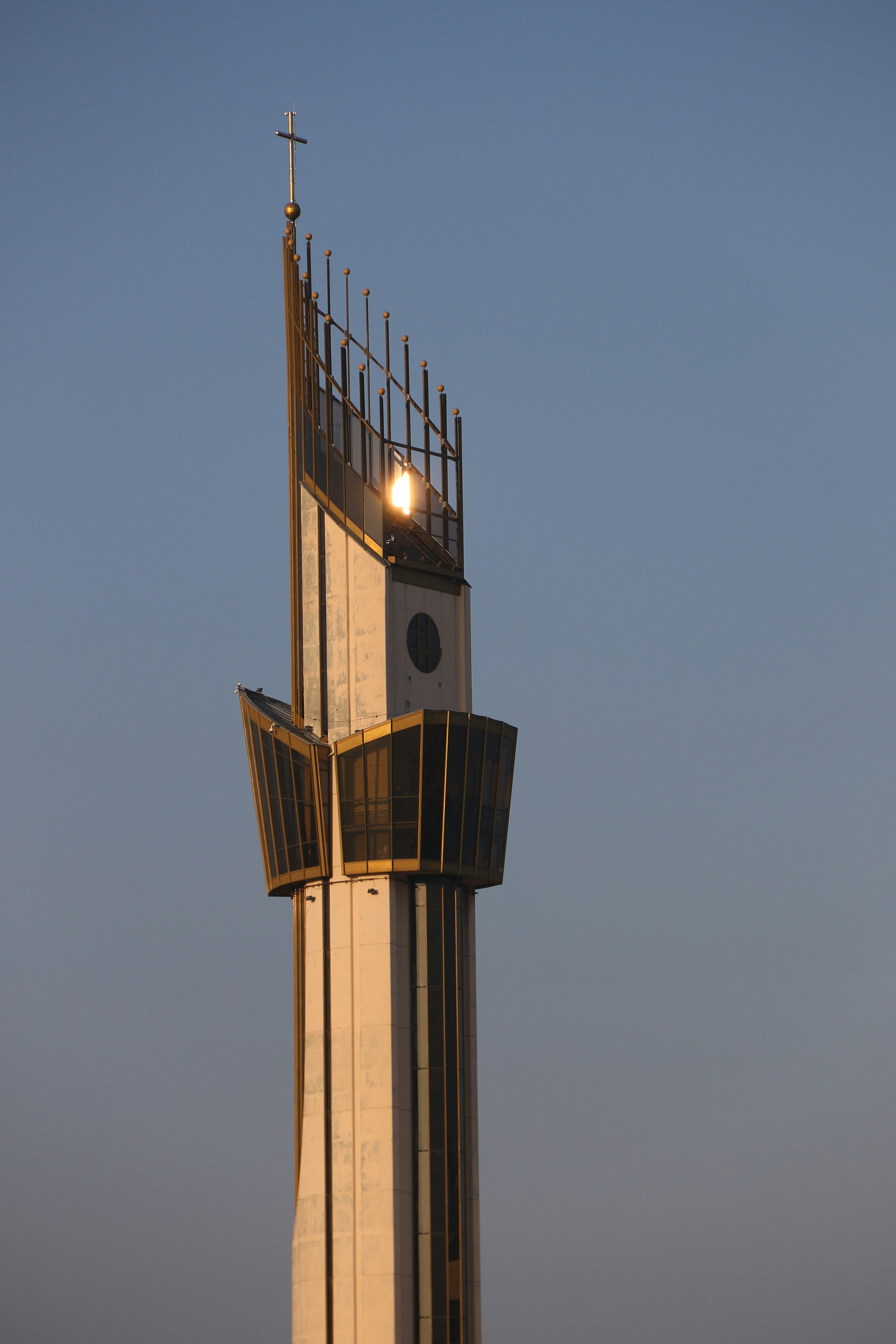 Sunlit Spire Crown: A Modern Church Tower Reaching Toward a Clear Blue Sky