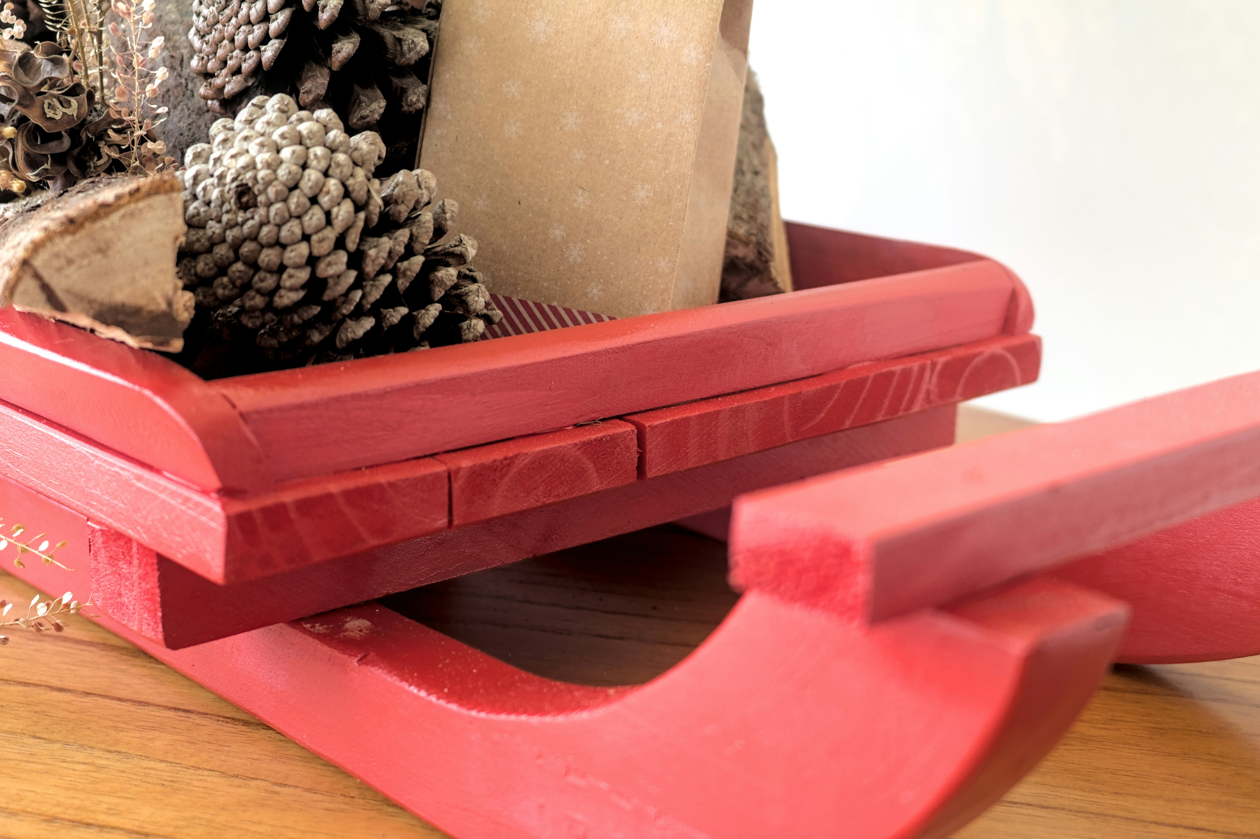 A red sled filled with lots of pine cones photo – Free Christmas Image ...