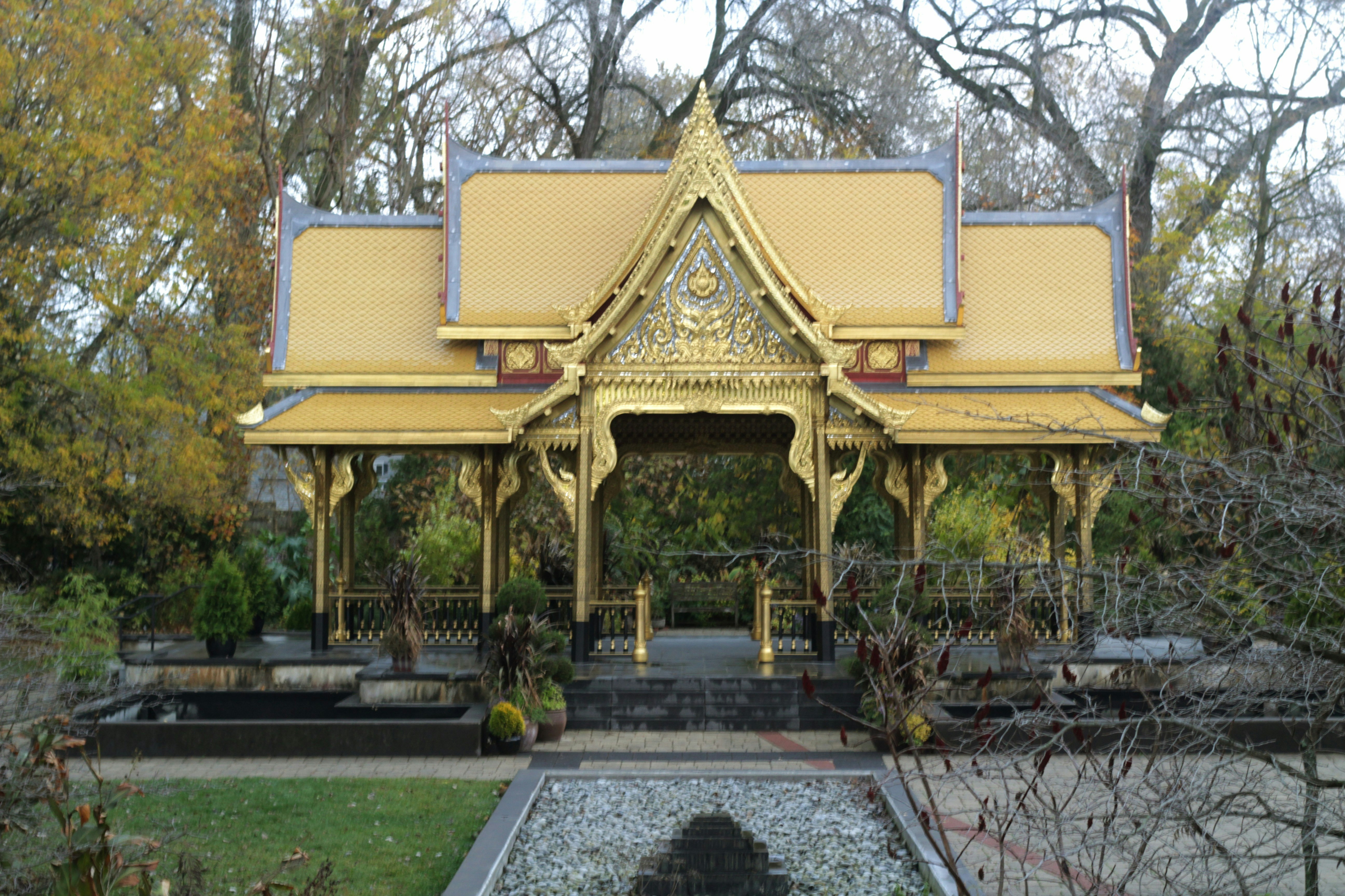 The Thai Pavilion at Olbrich Botanical Gardens in Madison, Wisconsin. This beautiful structure features a traditional Thai design with a golden roof and intricate carvings. It serves as a serene space within the gardens, offering a glimpse into Thai architectural style.