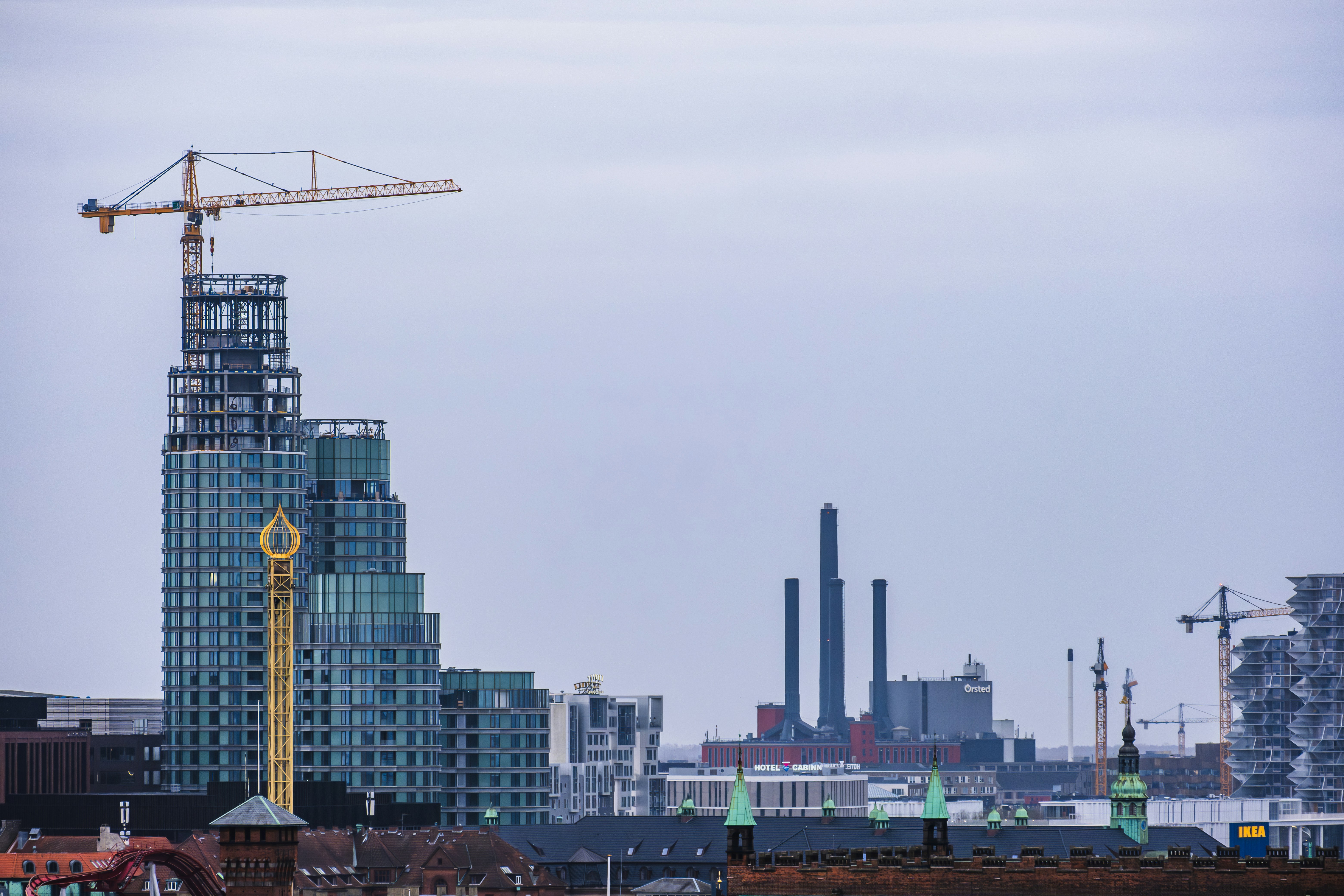 A crane is standing in front of a large city
