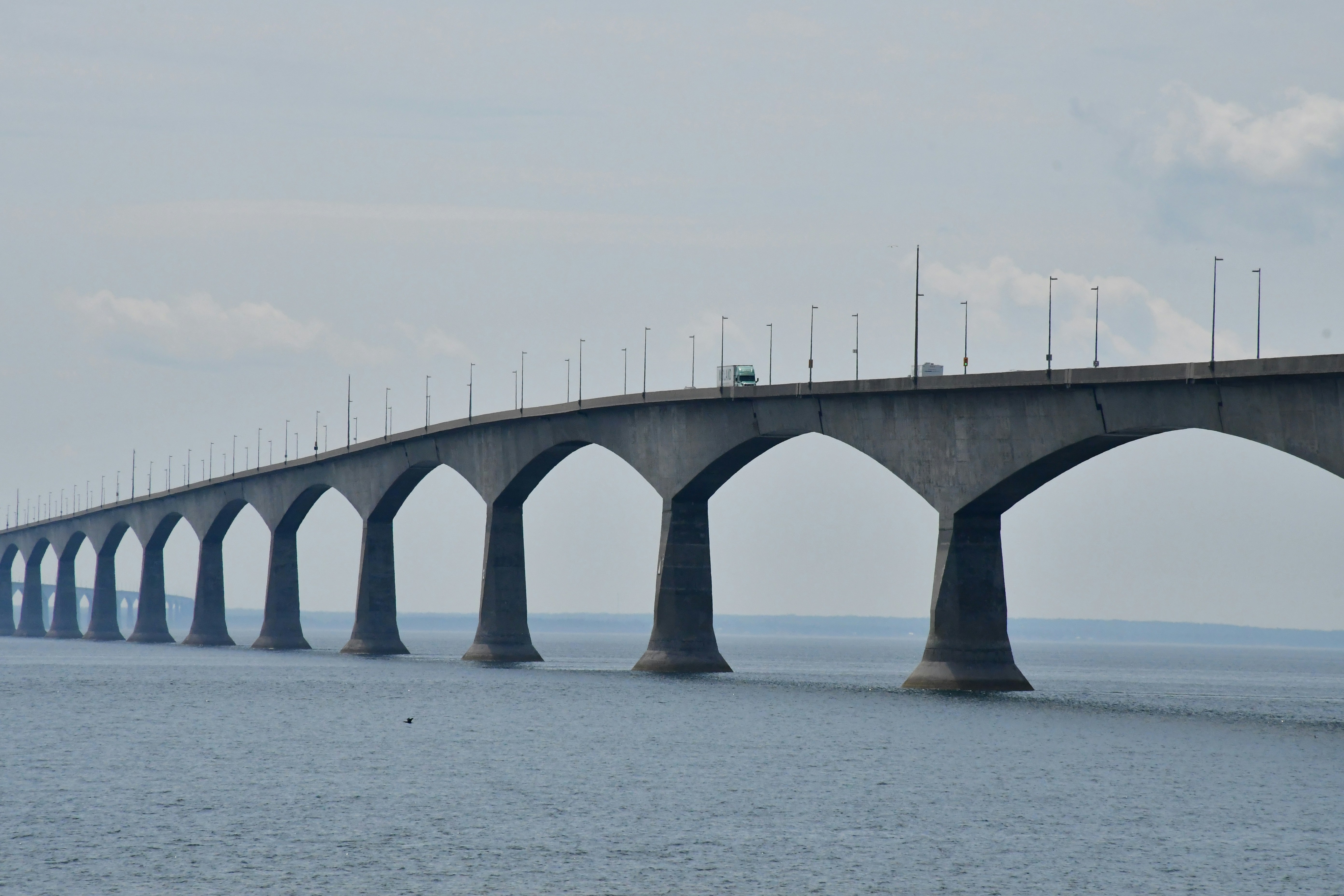 A long bridge spanning over a large body of water photo – Free Pei ...