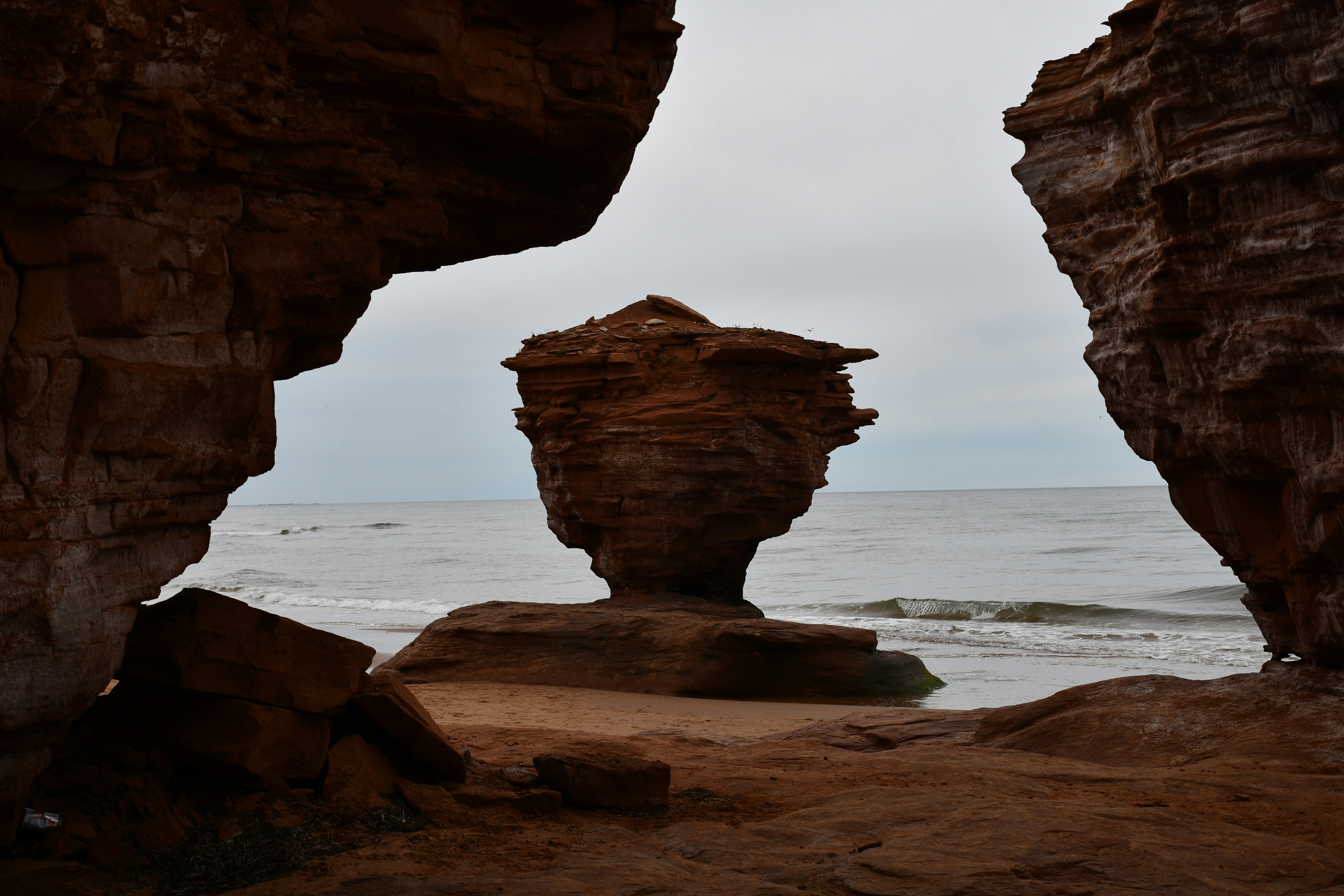 A large rock formation sitting on top of a beach photo – Free Pei Image ...
