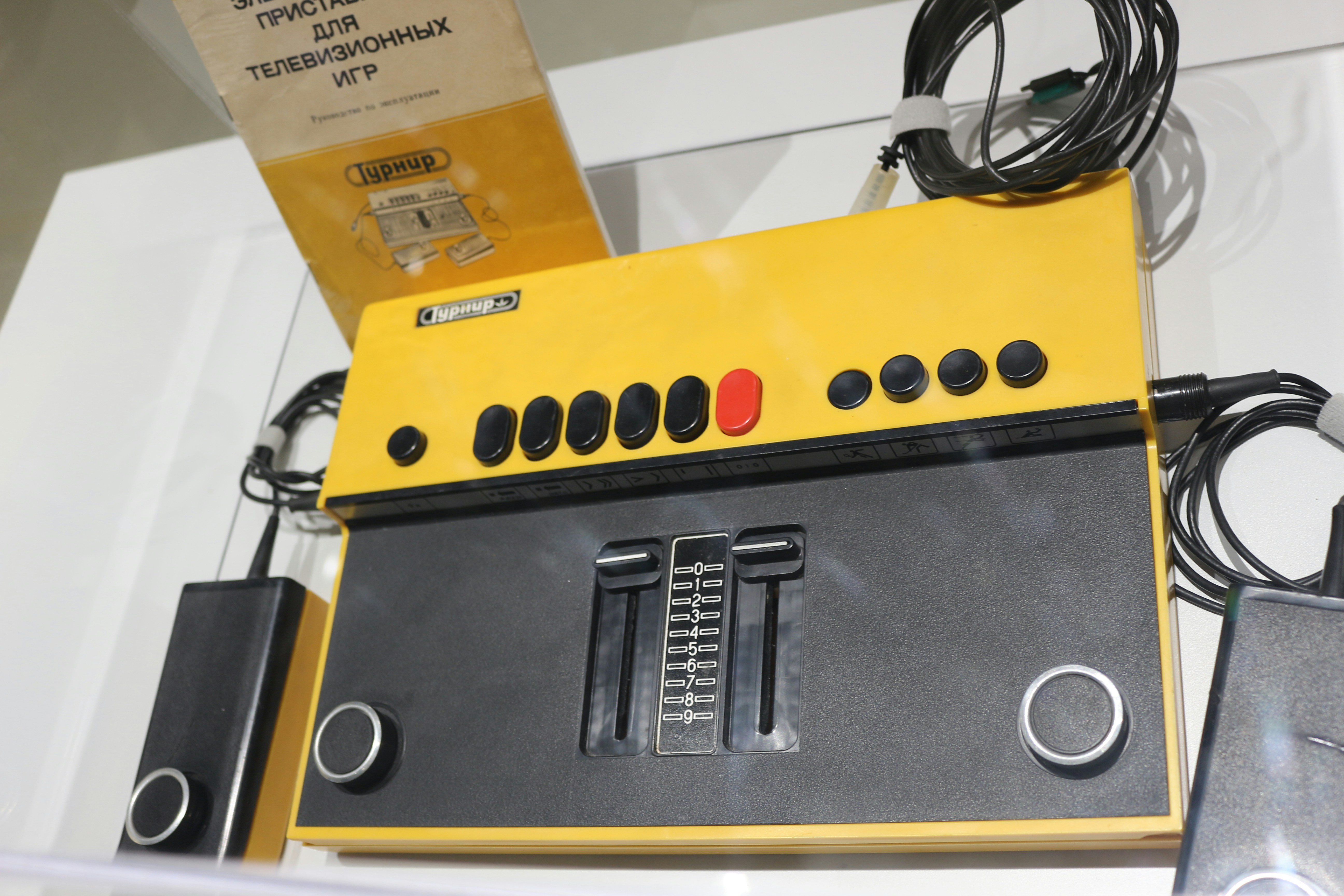 A yellow electronic device sitting on top of a table photo – Free ...