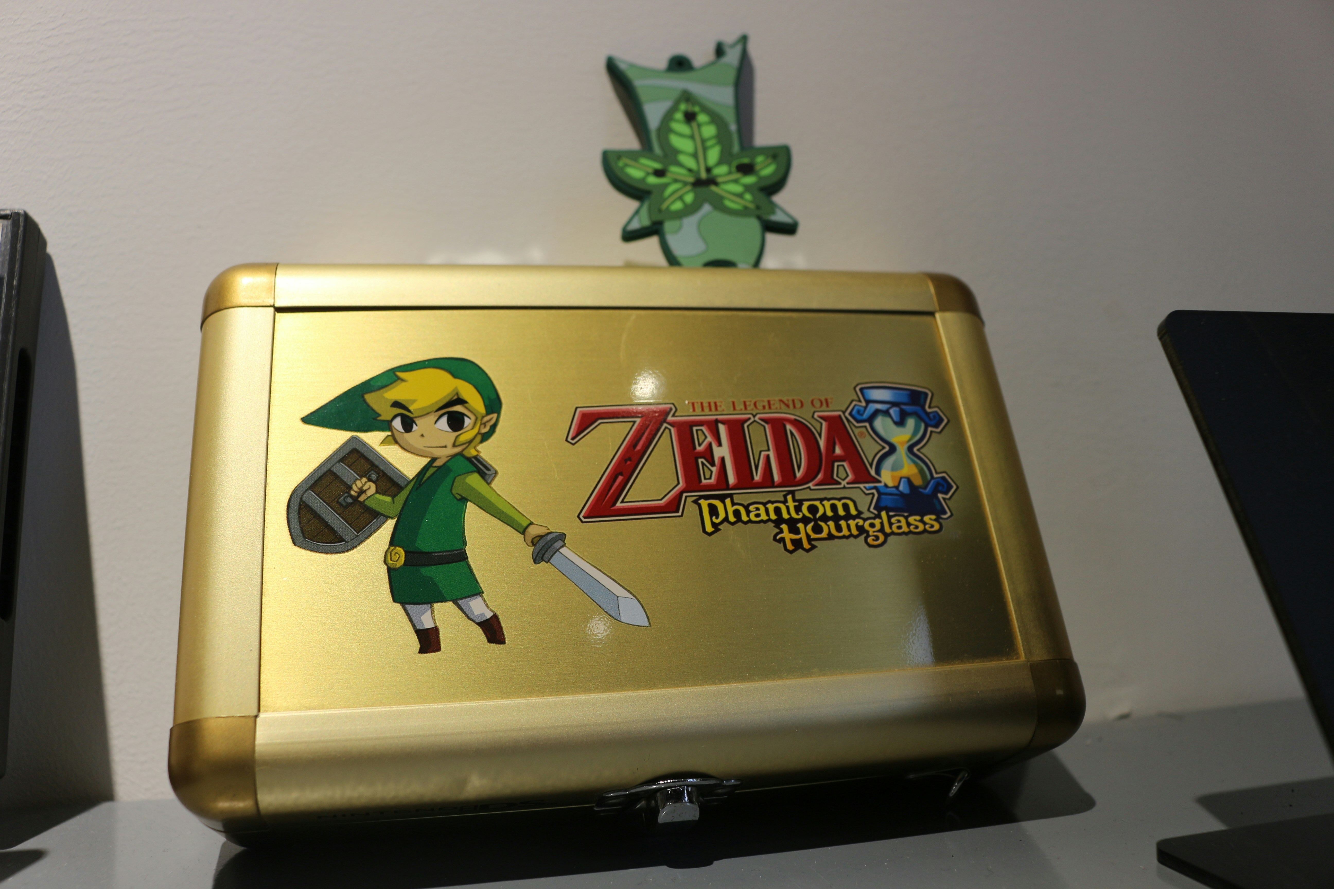 Gilded Zelda Tin: Phantom Hourglass on Display with a Tiny Deku Leaf Guardian
