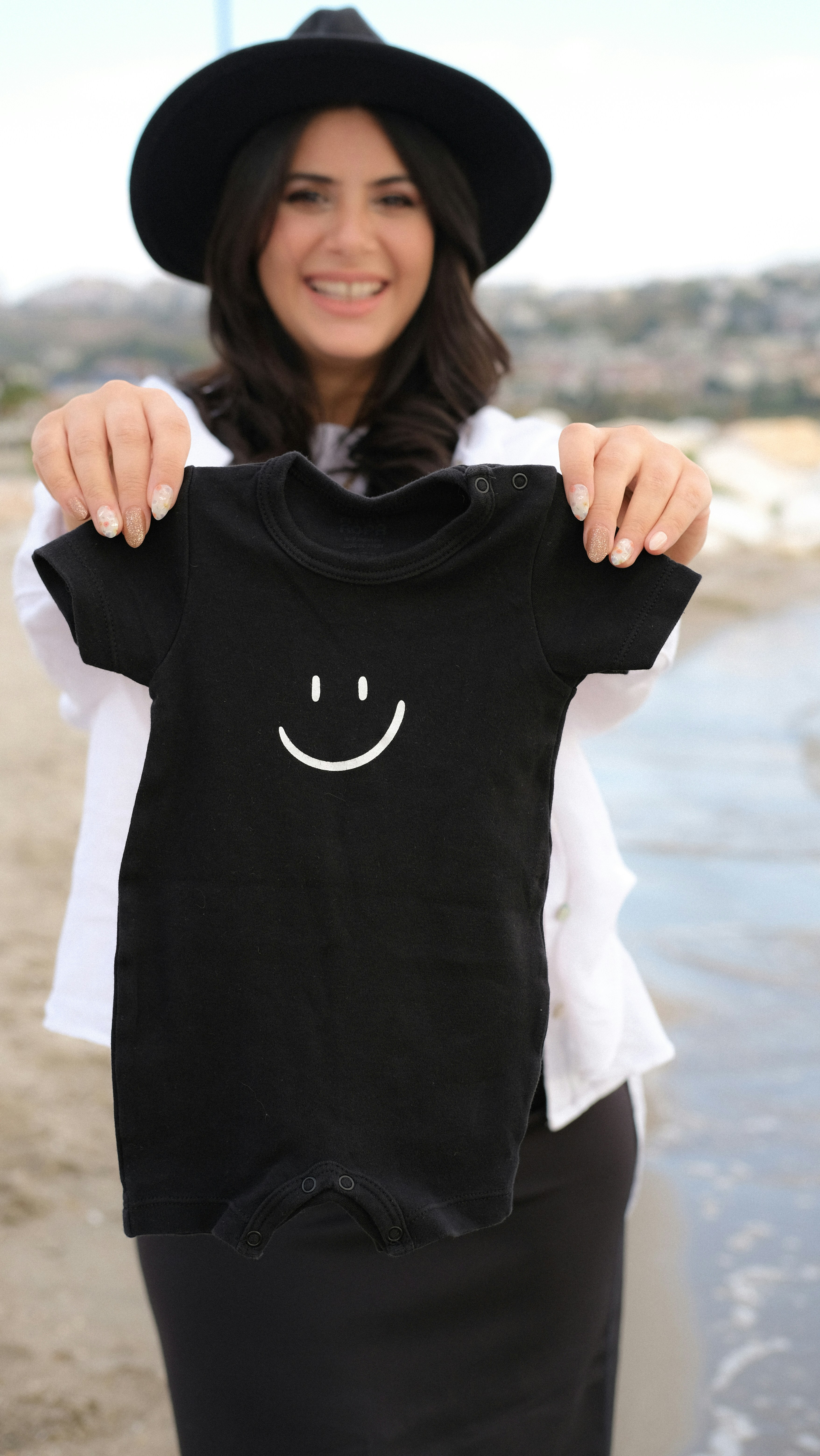 Shoreline Spotlight: A Black Onesie with a White Smile Takes Center Stage