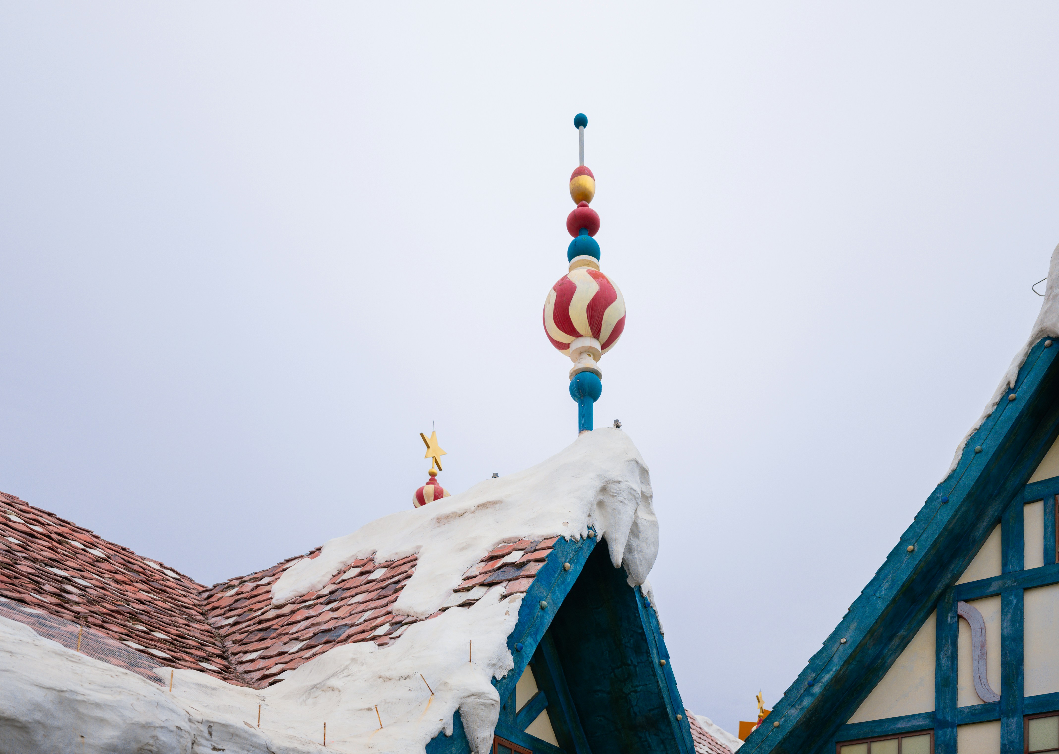 Prismatic Spire Crowns Snow-Capped Roofs Under a Pale Winter Sky