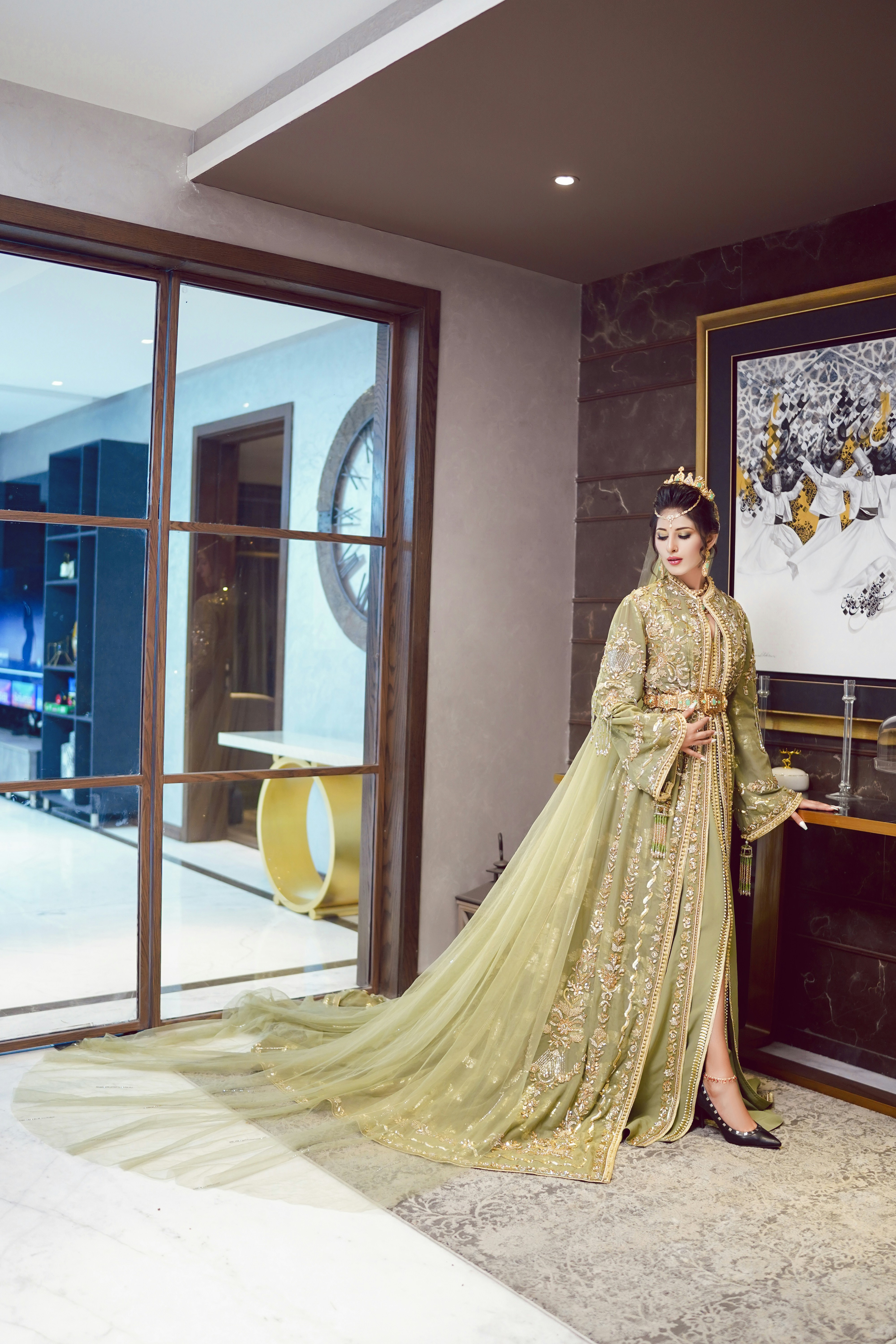 Emerald Gown Unfurls a Regal Train in a Modern Foyer