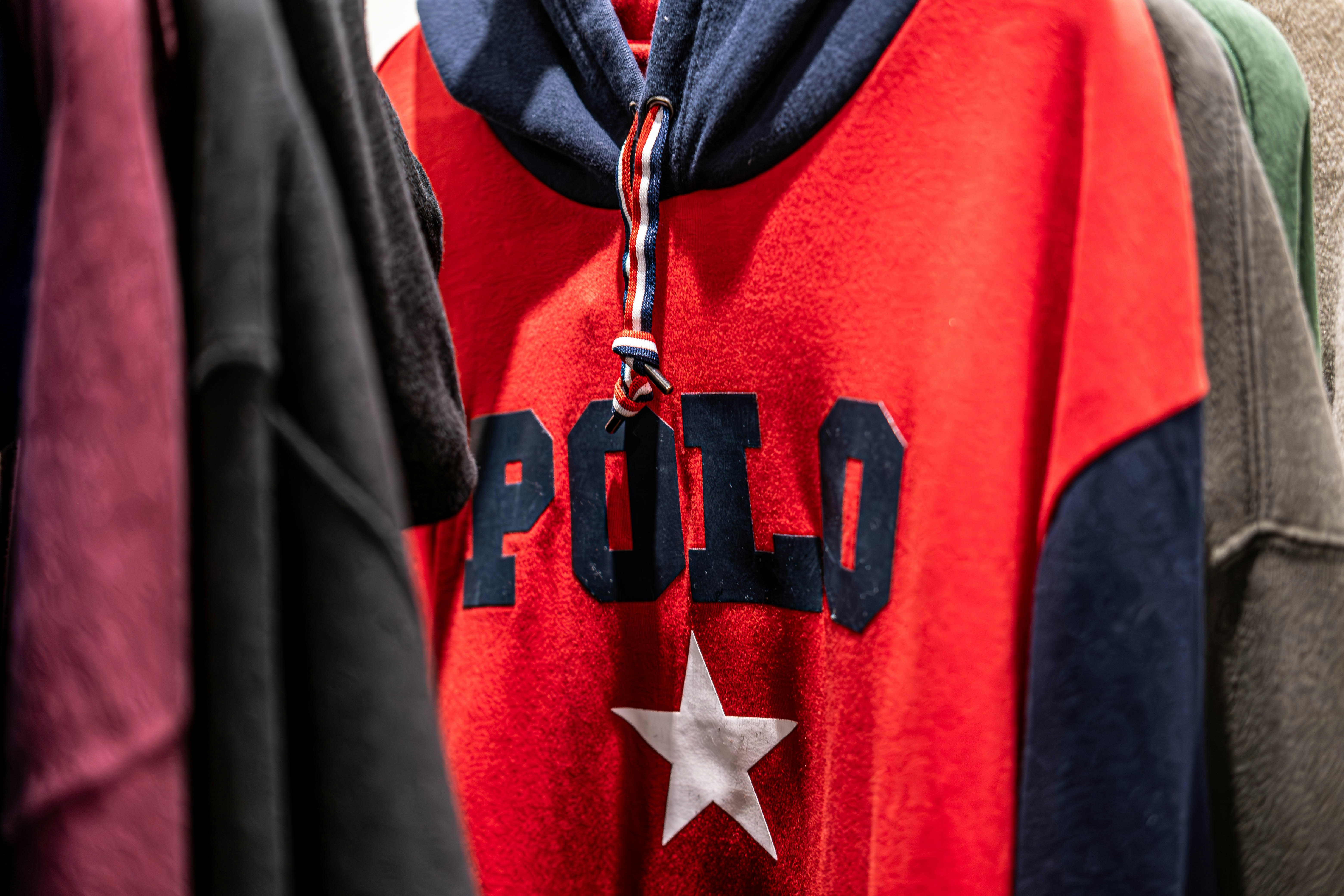 Centerstage Polo Hoodie: Red with White Star Amid Quiet Wardrobe